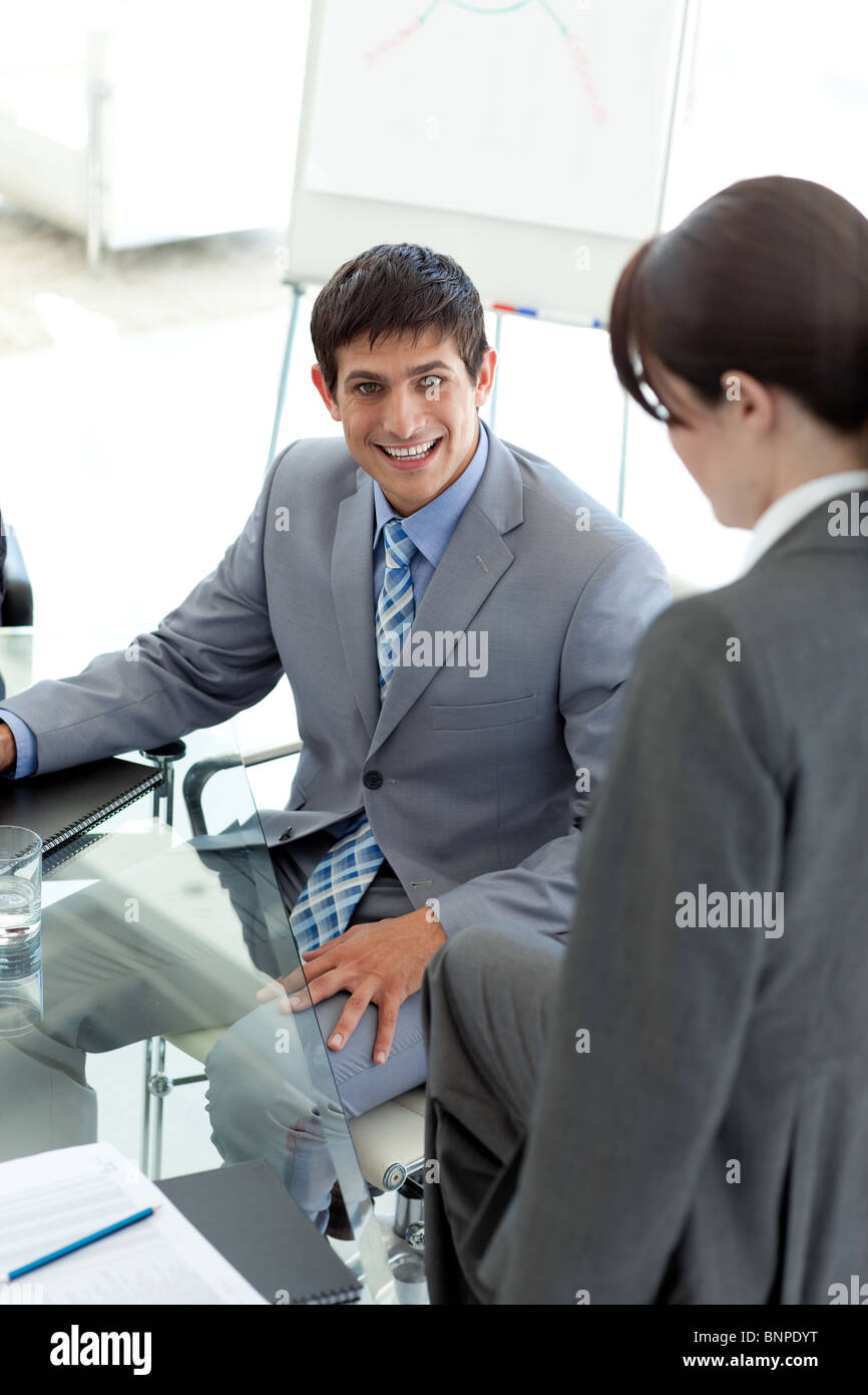 Young businessman sitting at a conference table Stock Photo - Alamy