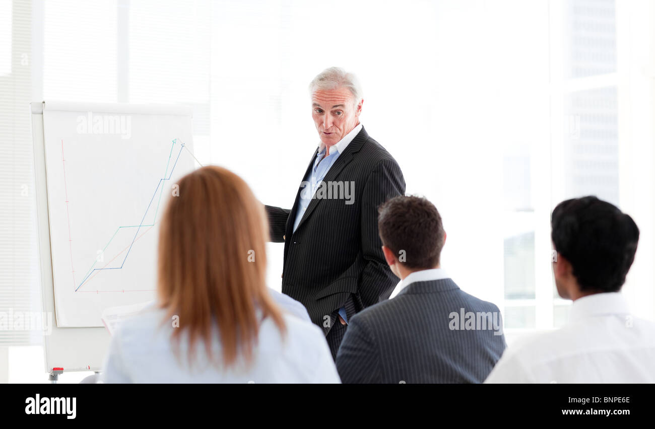 Senior businessman giving presentation team hi-res stock photography ...
