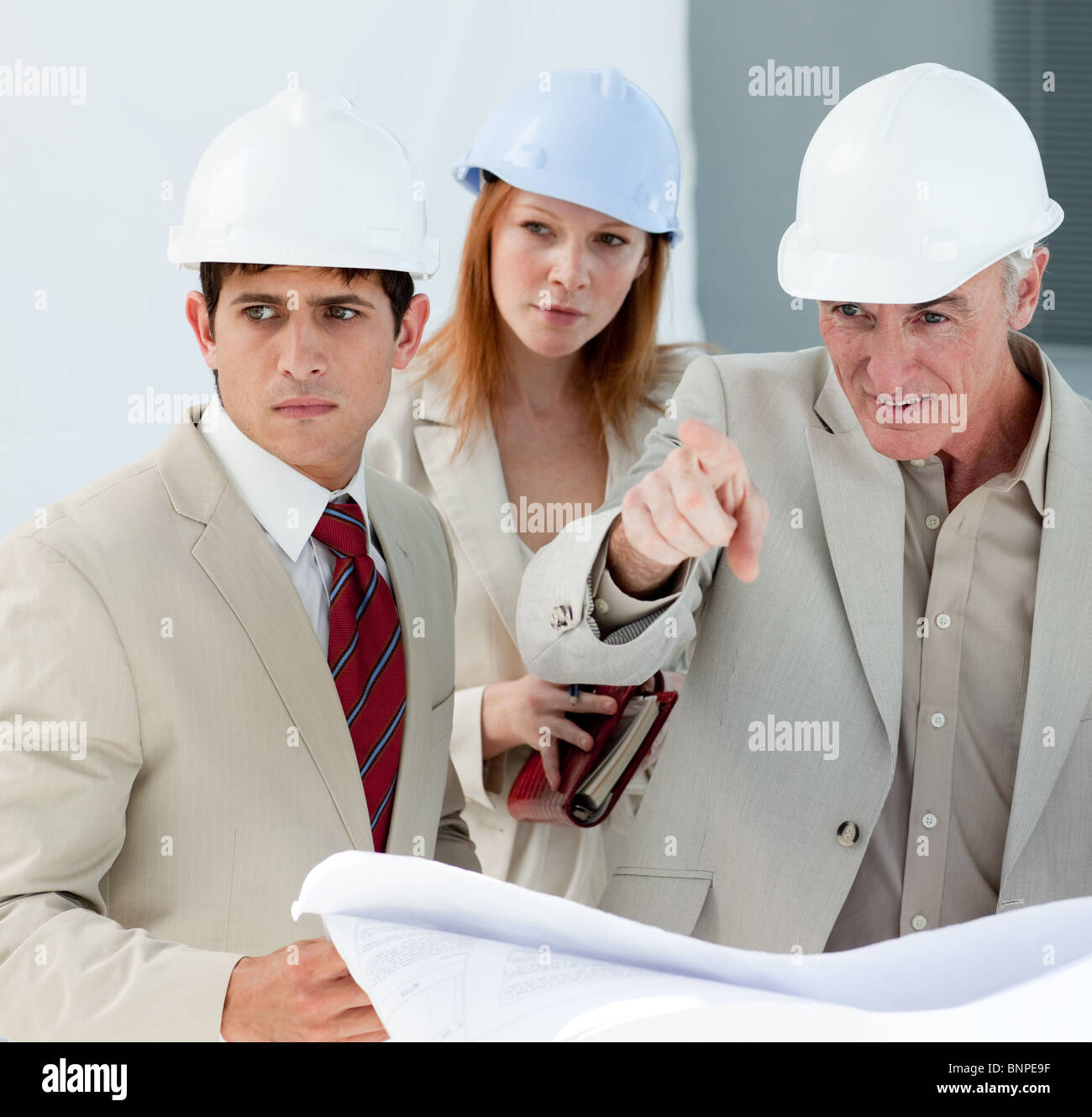 Engineers studying blueprints Stock Photo - Alamy