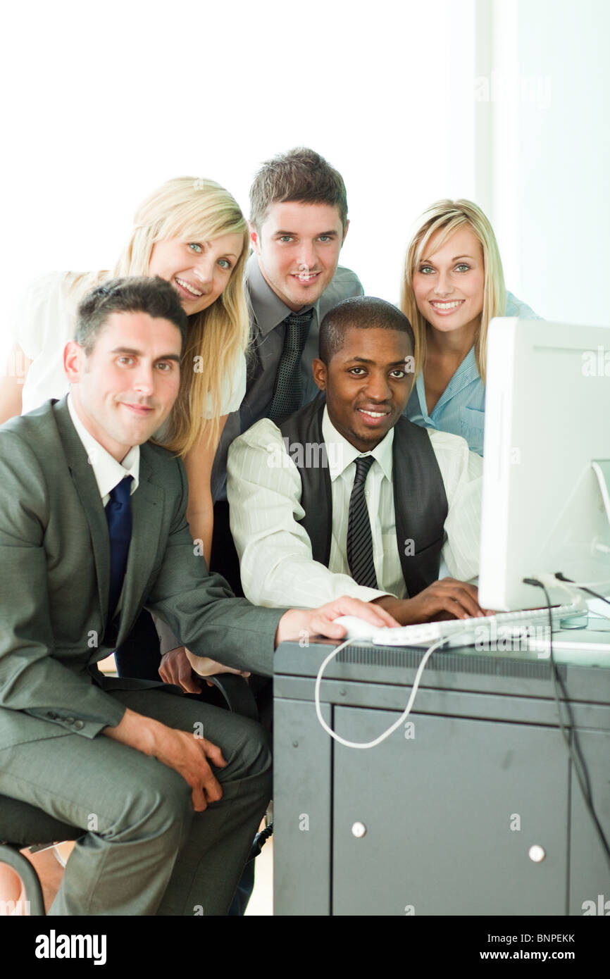 Smiling international business team working in office Stock Photo - Alamy