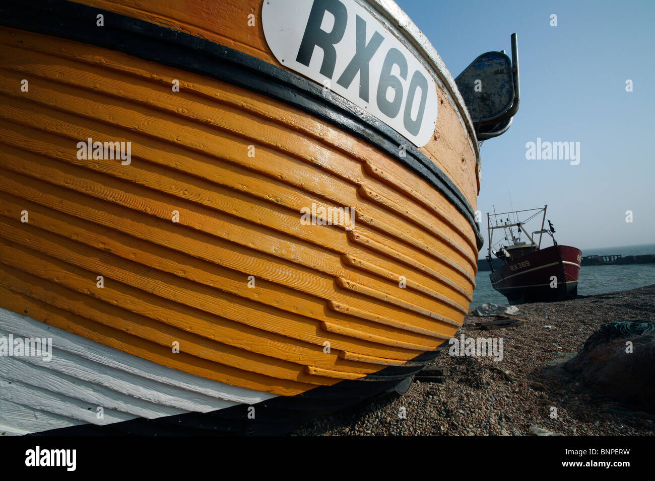A close up of the clinker timber form of a fishing boat beached at ...