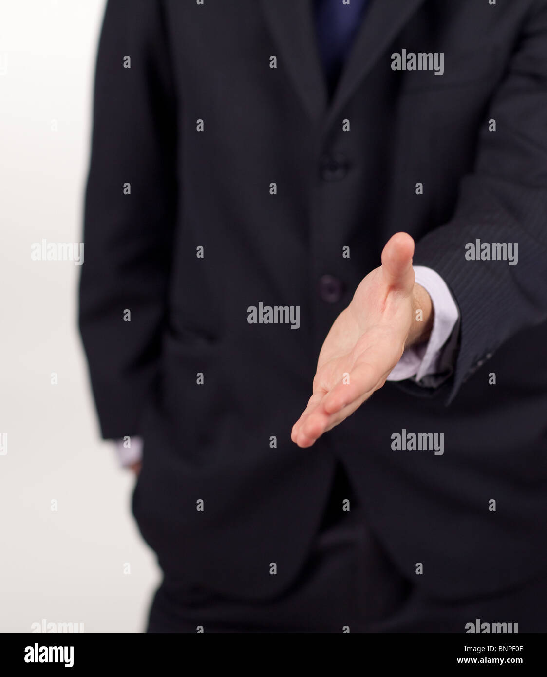 businessman showing a handshake to the camera Stock Photo - Alamy