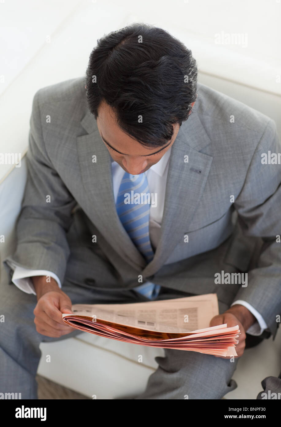 Businessman reading a newspaper while waiting for a job interview Stock ...