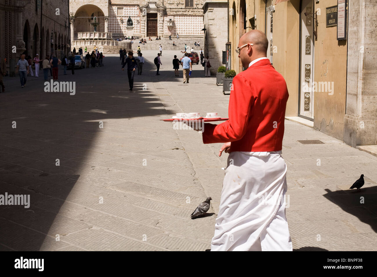 waiter in red jacket carries a tray in a street cafe Stock Photo - Alamy