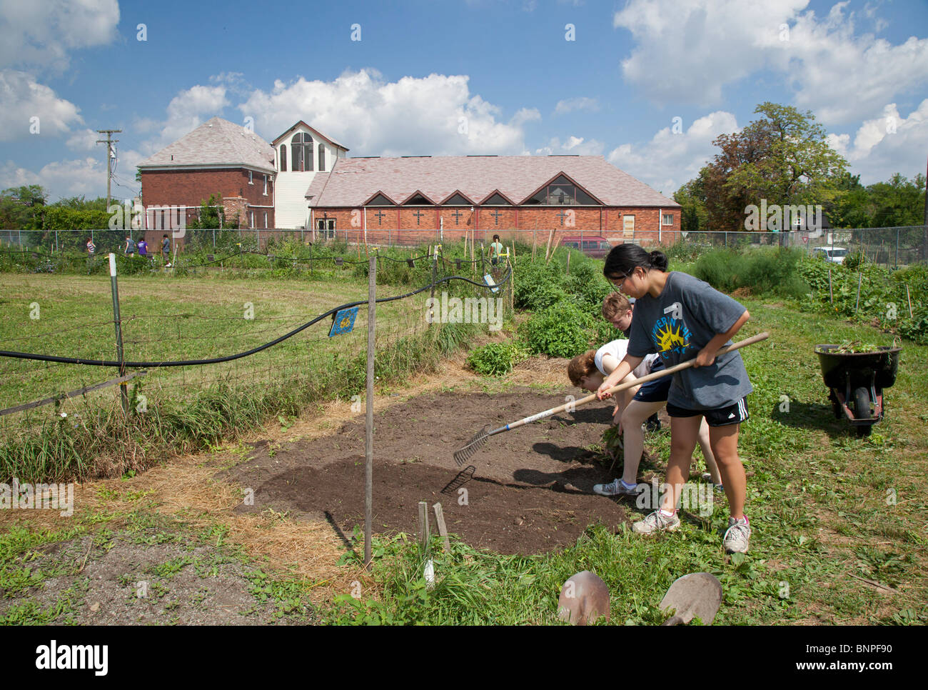 High School Volunteers Work in Garden at Public School Stock Photo - Alamy