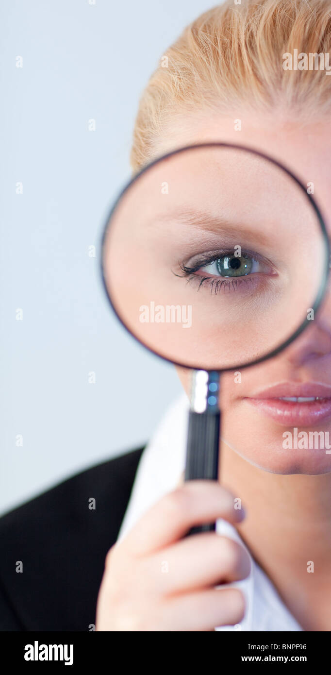 Serious Business woman looking through a magnifying Glass Stock Photo ...