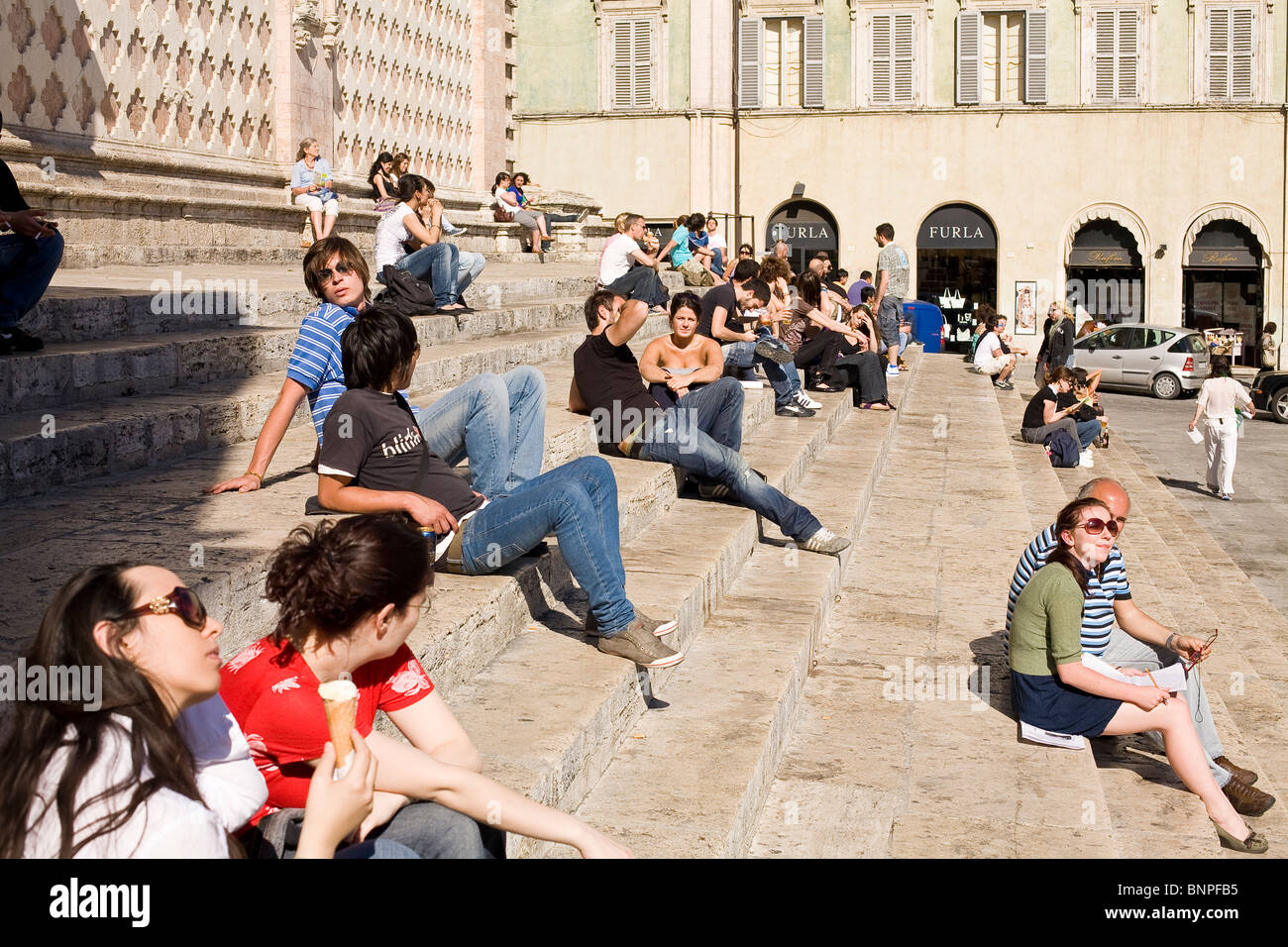 young people sitting on steps of cathedral in Perugia, Italy Stock ...