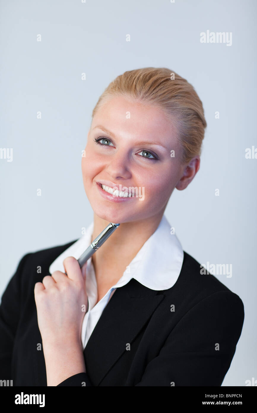 Businesswoman with pen in her hand Stock Photo - Alamy