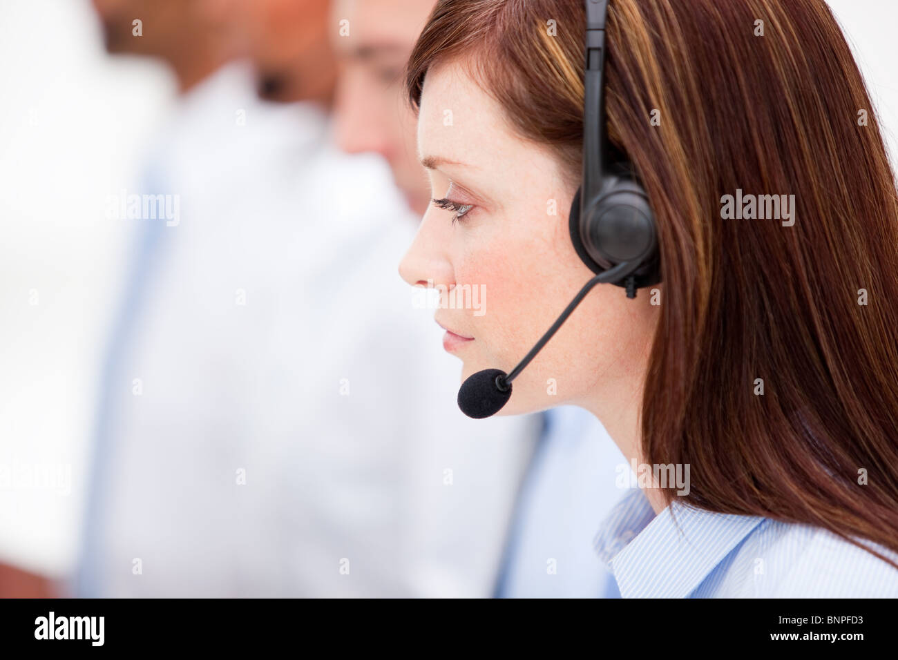 Close-up of a female customer service agent and her team Stock Photo ...