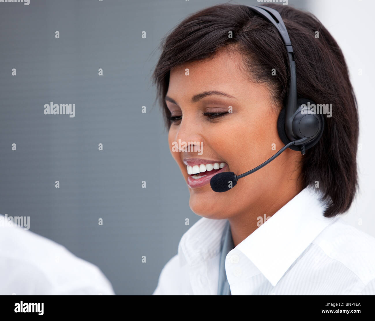 Portrait of a laughing customer service agent at work Stock Photo - Alamy