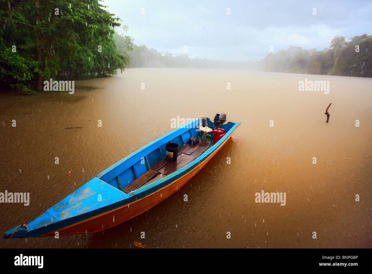 Fisherman boat in lake at rain time Stock Photo - Alamy