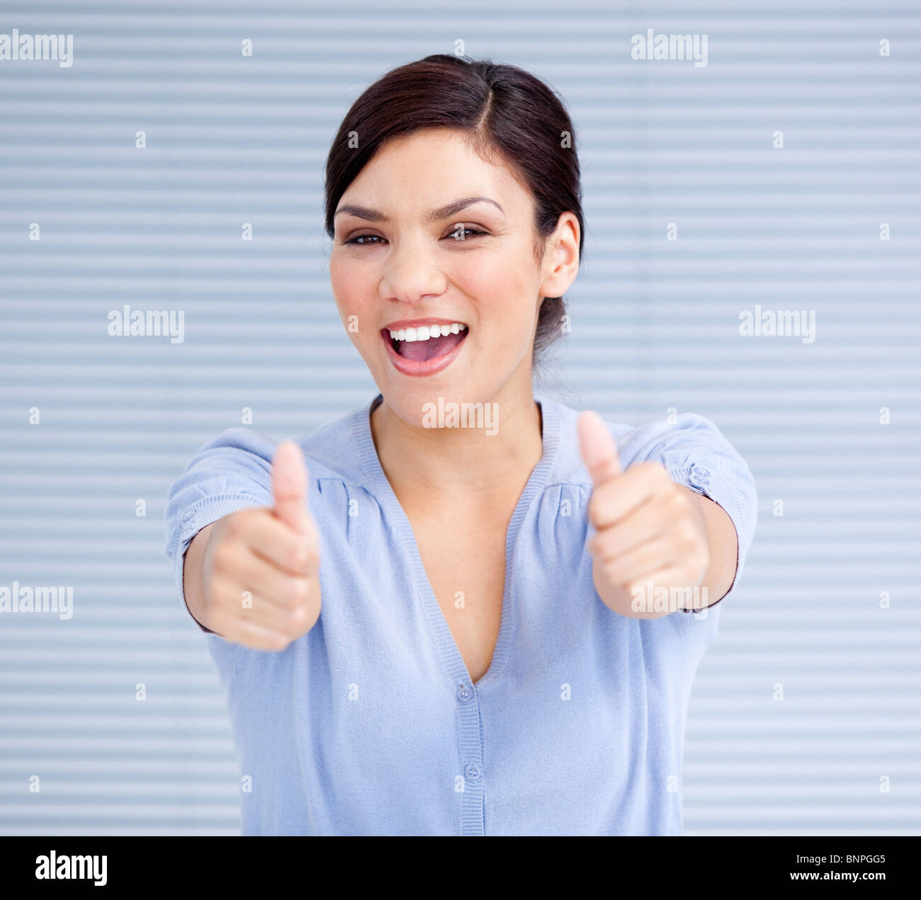 Successful businesswoman with thumbs up Stock Photo - Alamy