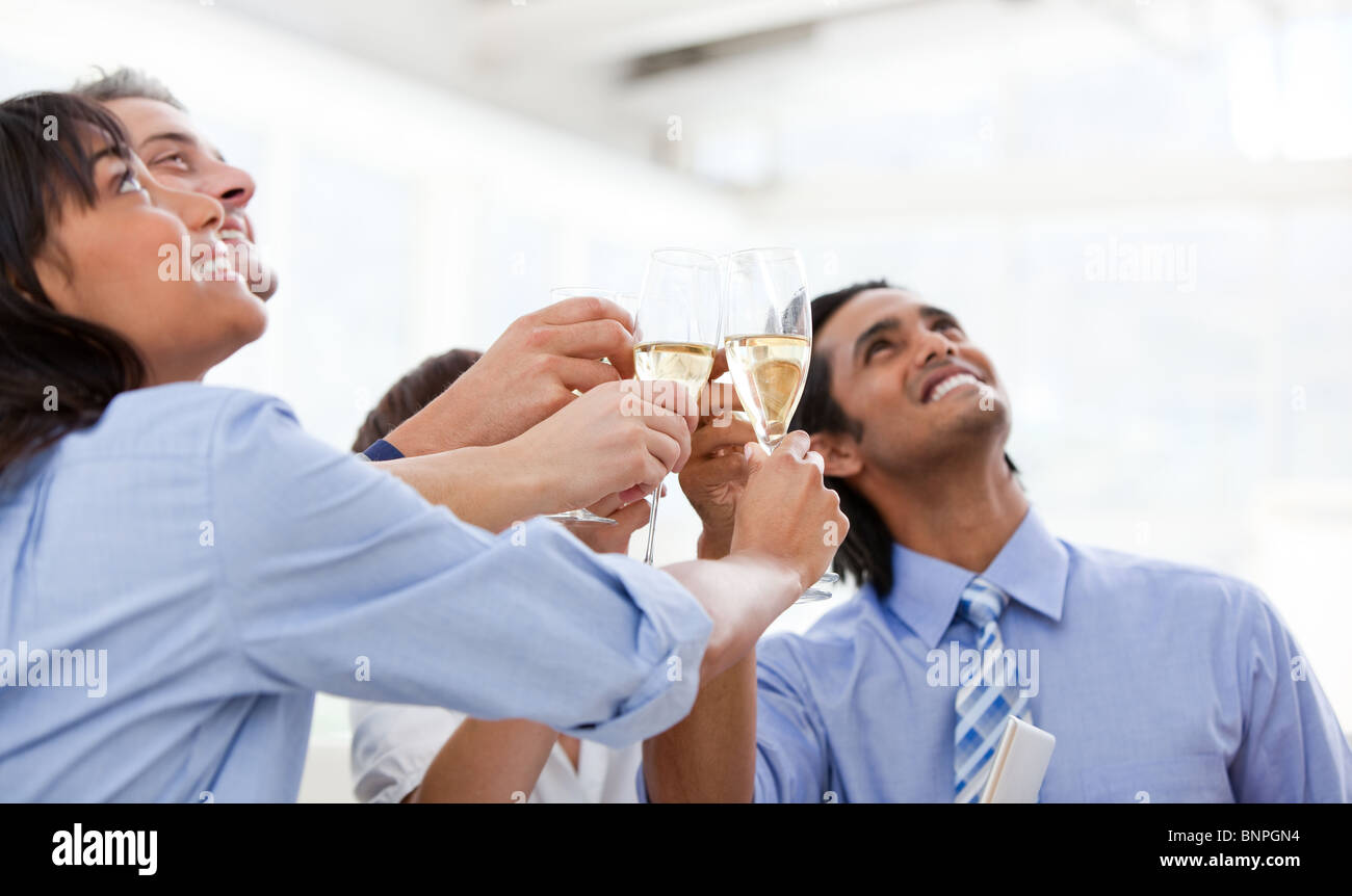 Cheerful business team toasting with Champagne Stock Photo - Alamy