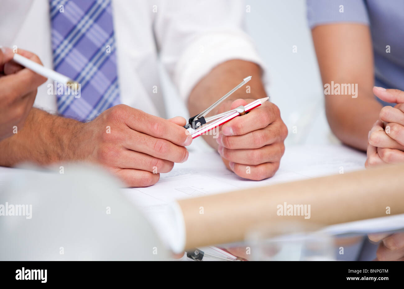Close-up of architects studying blueprints Stock Photo - Alamy