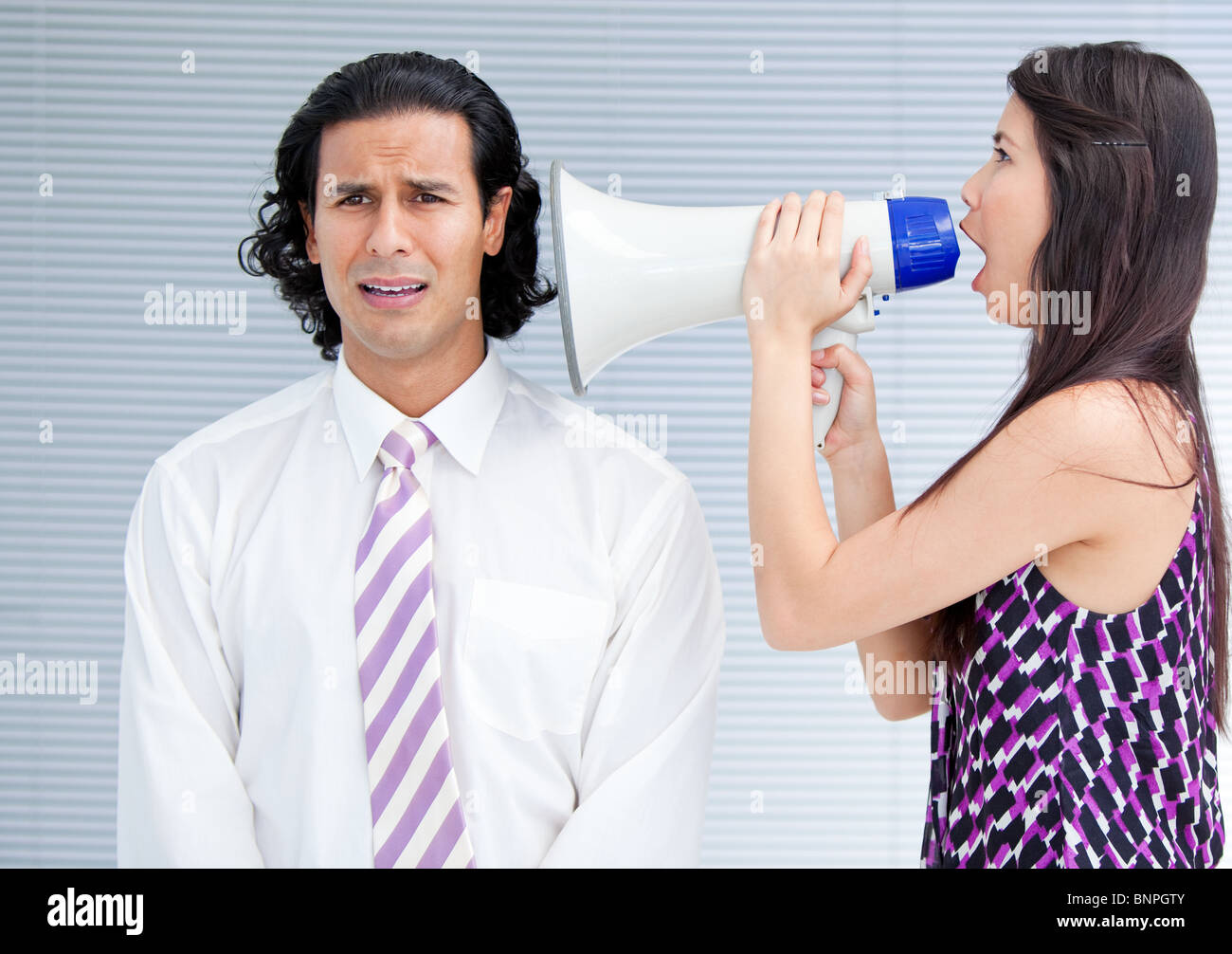 Angry businesswoman yelling through a megaphone Stock Photo - Alamy