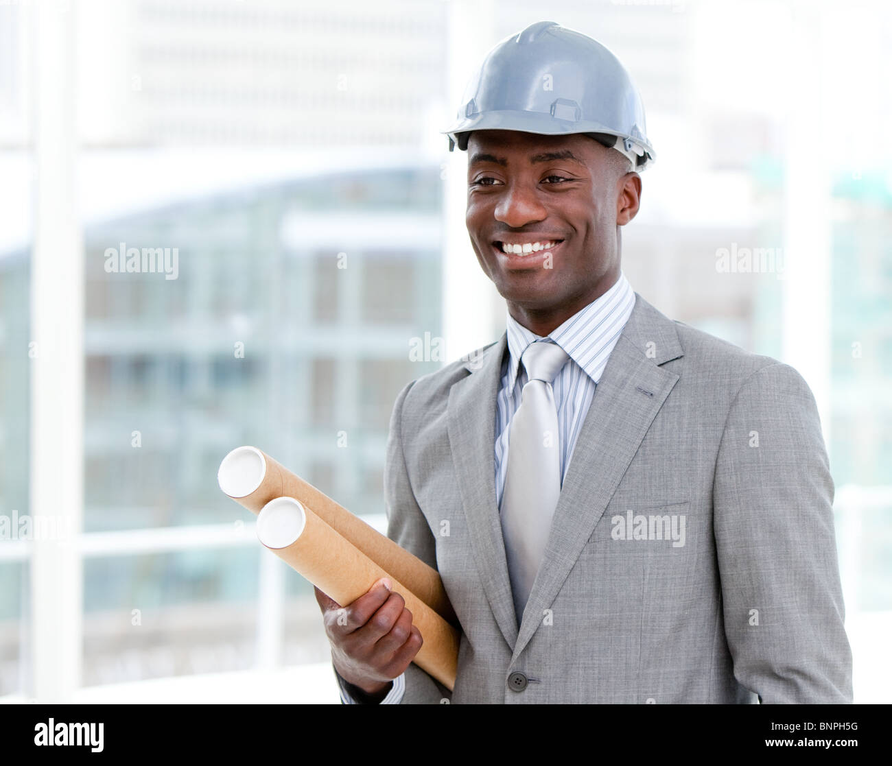 Portrait of a cheerful male architect holding blueprints Stock Photo ...