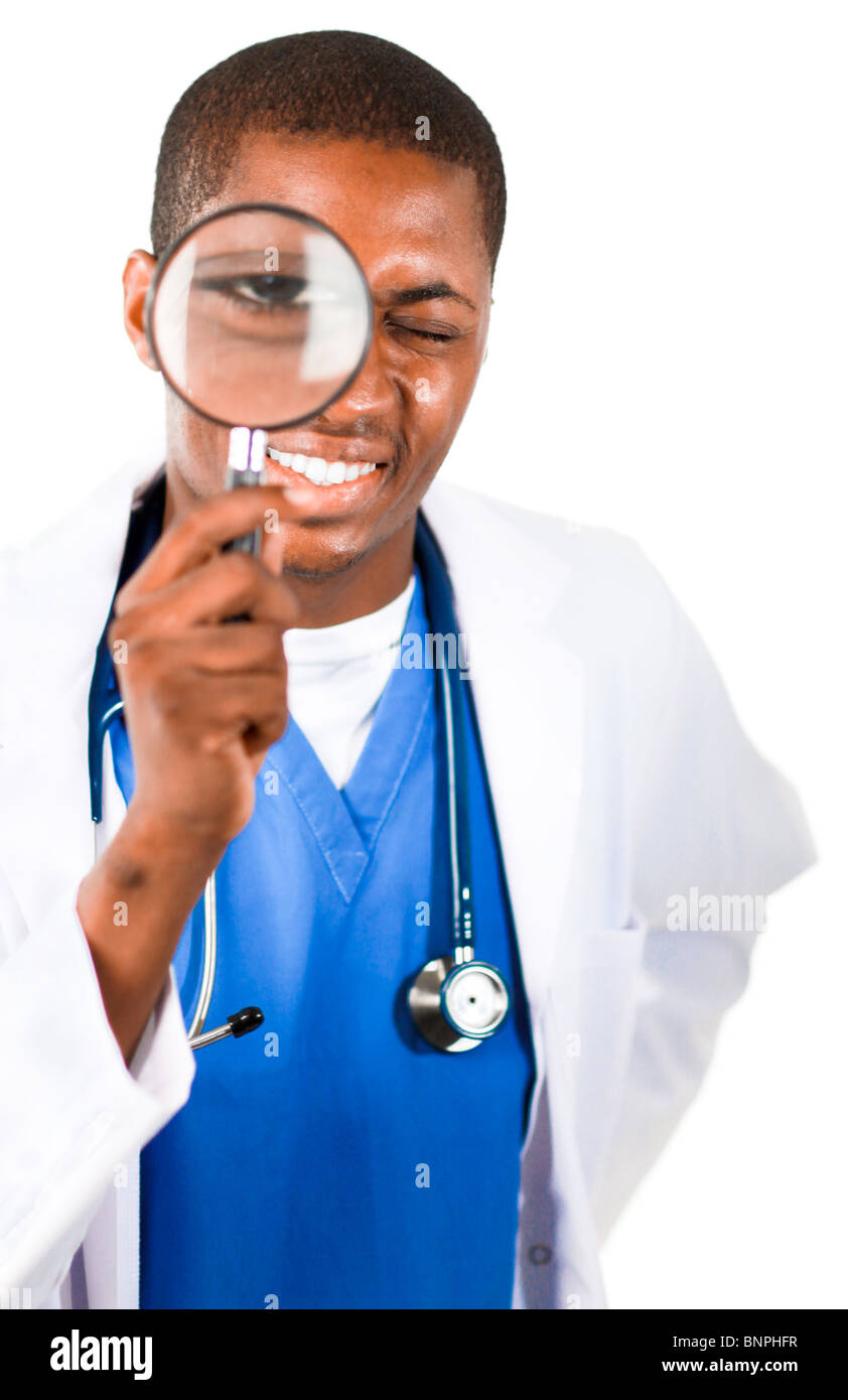 Handsome doctor looking through a magnifying glass and smiling Stock ...