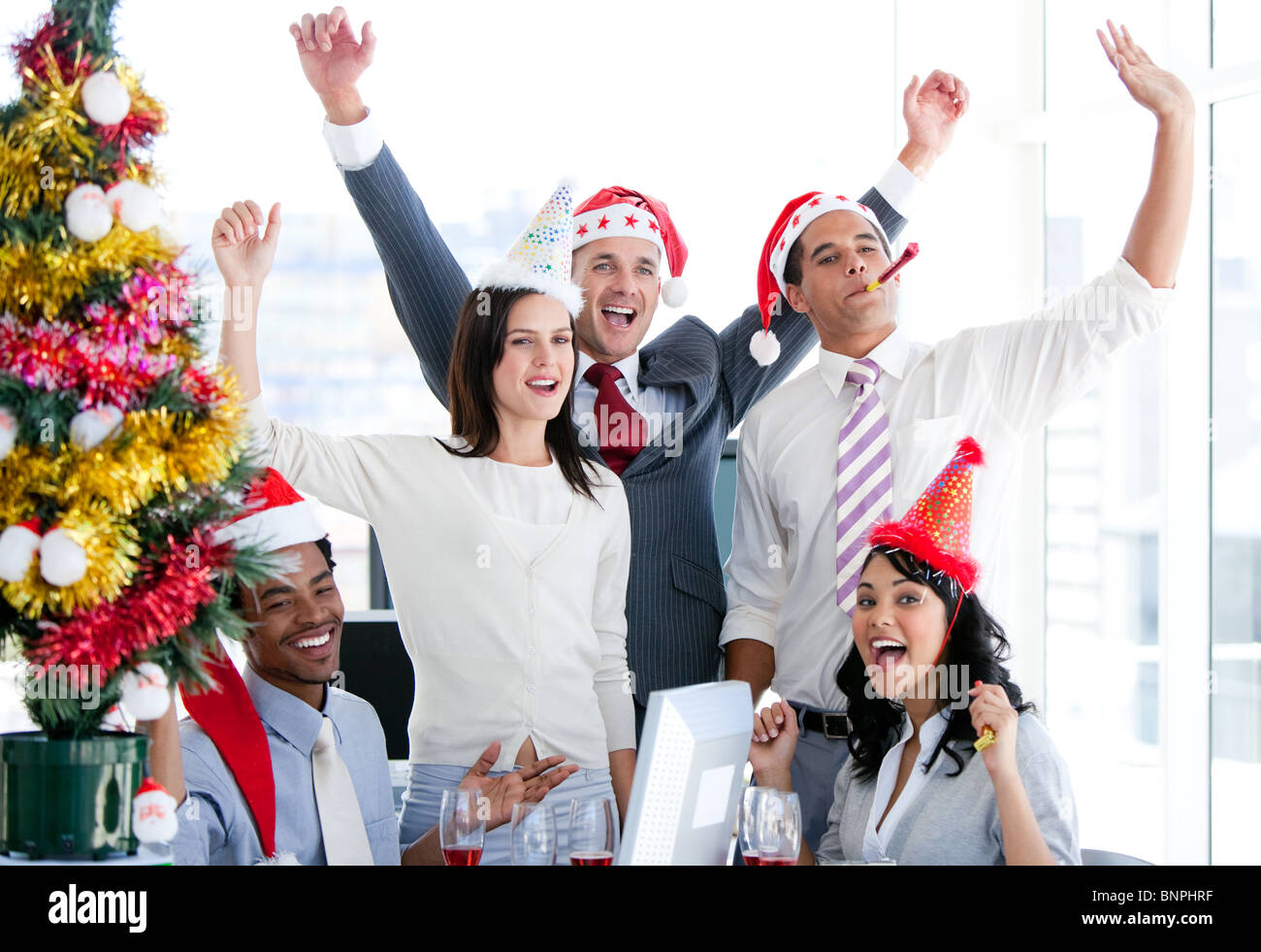 Nice business team punching the air to celebrate christmas Stock Photo ...