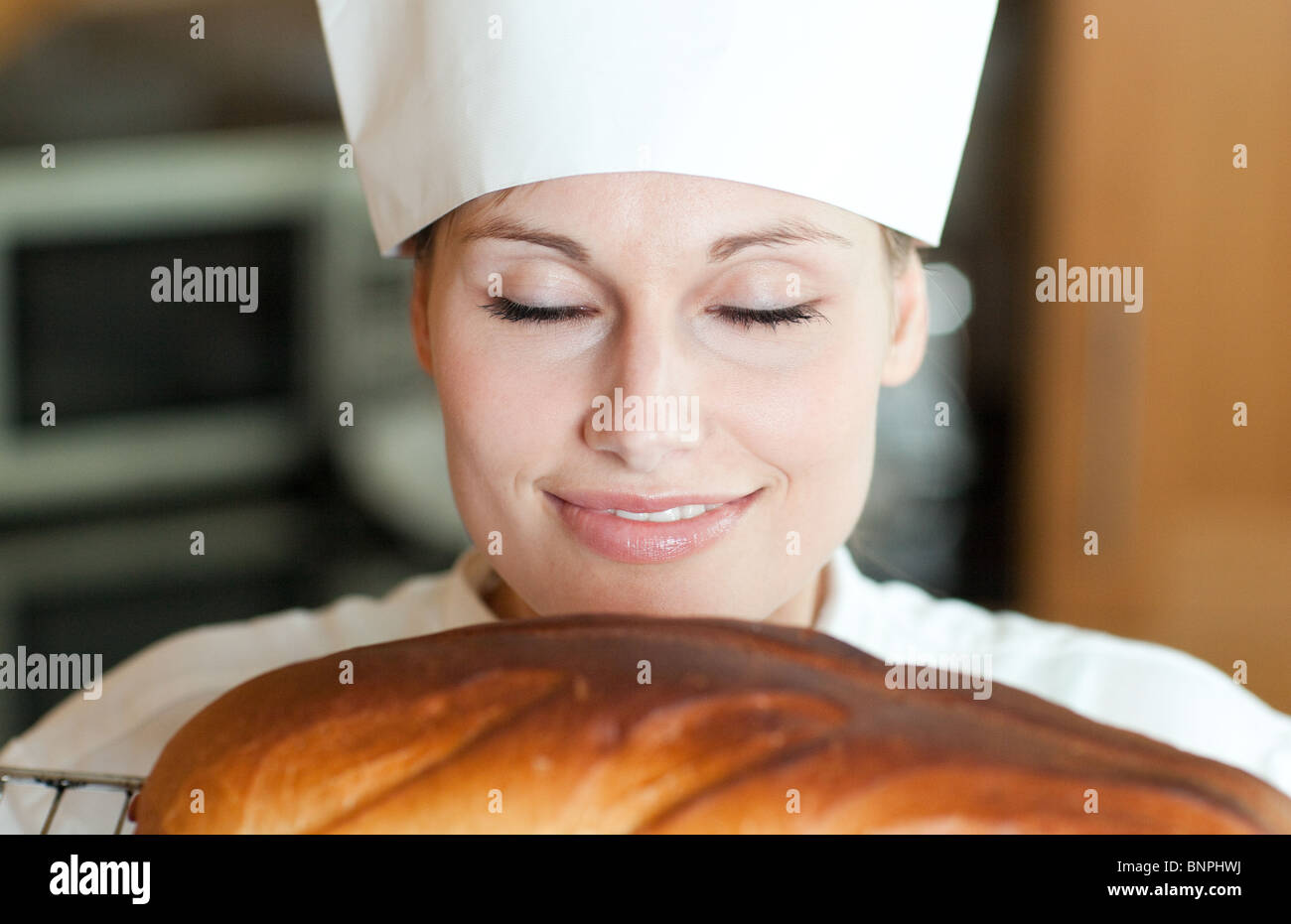 Radiant female chef baking bread Stock Photo - Alamy