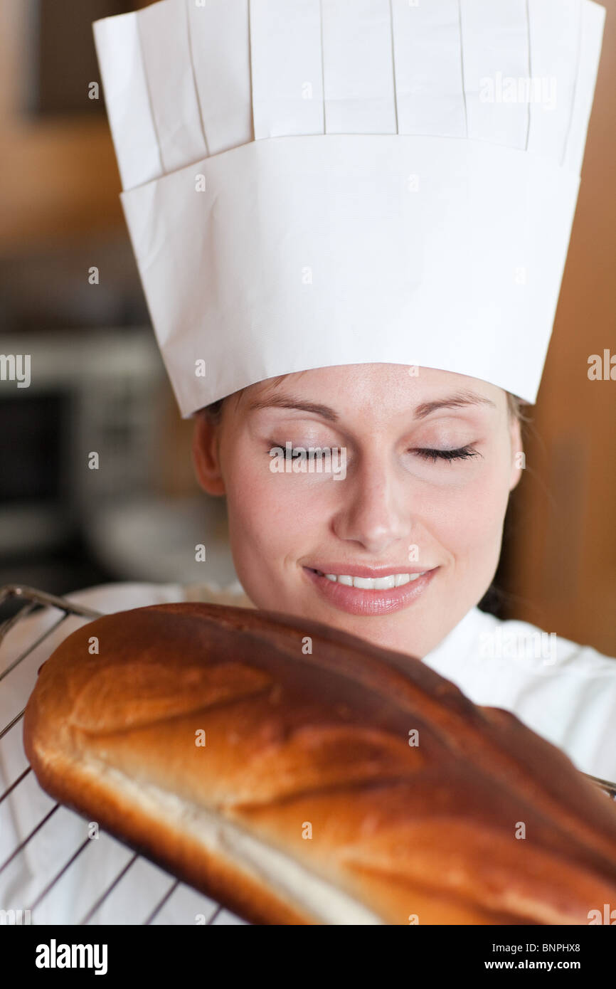 Bright female chef baking bread Stock Photo - Alamy