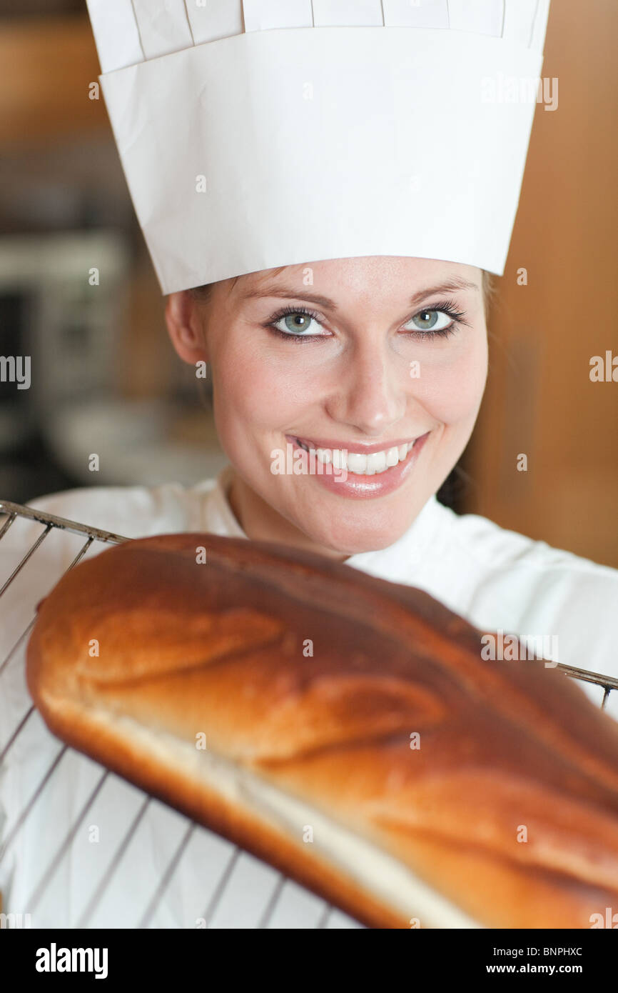 Cheerful female chef baking bread Stock Photo - Alamy