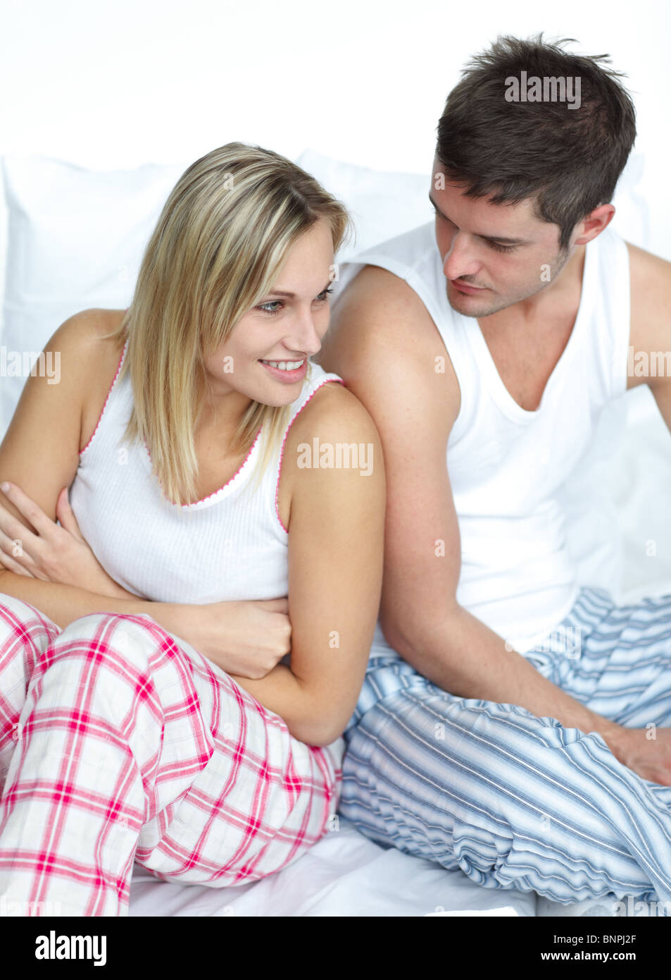 Couple having fun sitting in bed Stock Photo - Alamy
