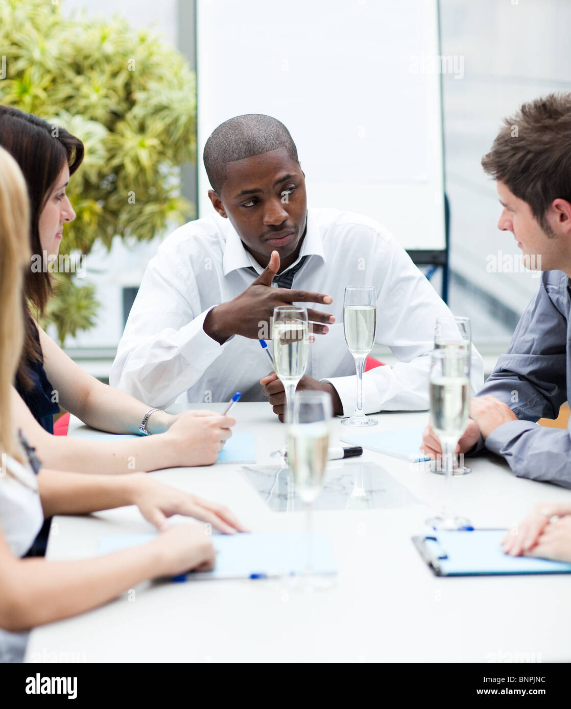 Manager speaking to his team with champagne Stock Photo - Alamy
