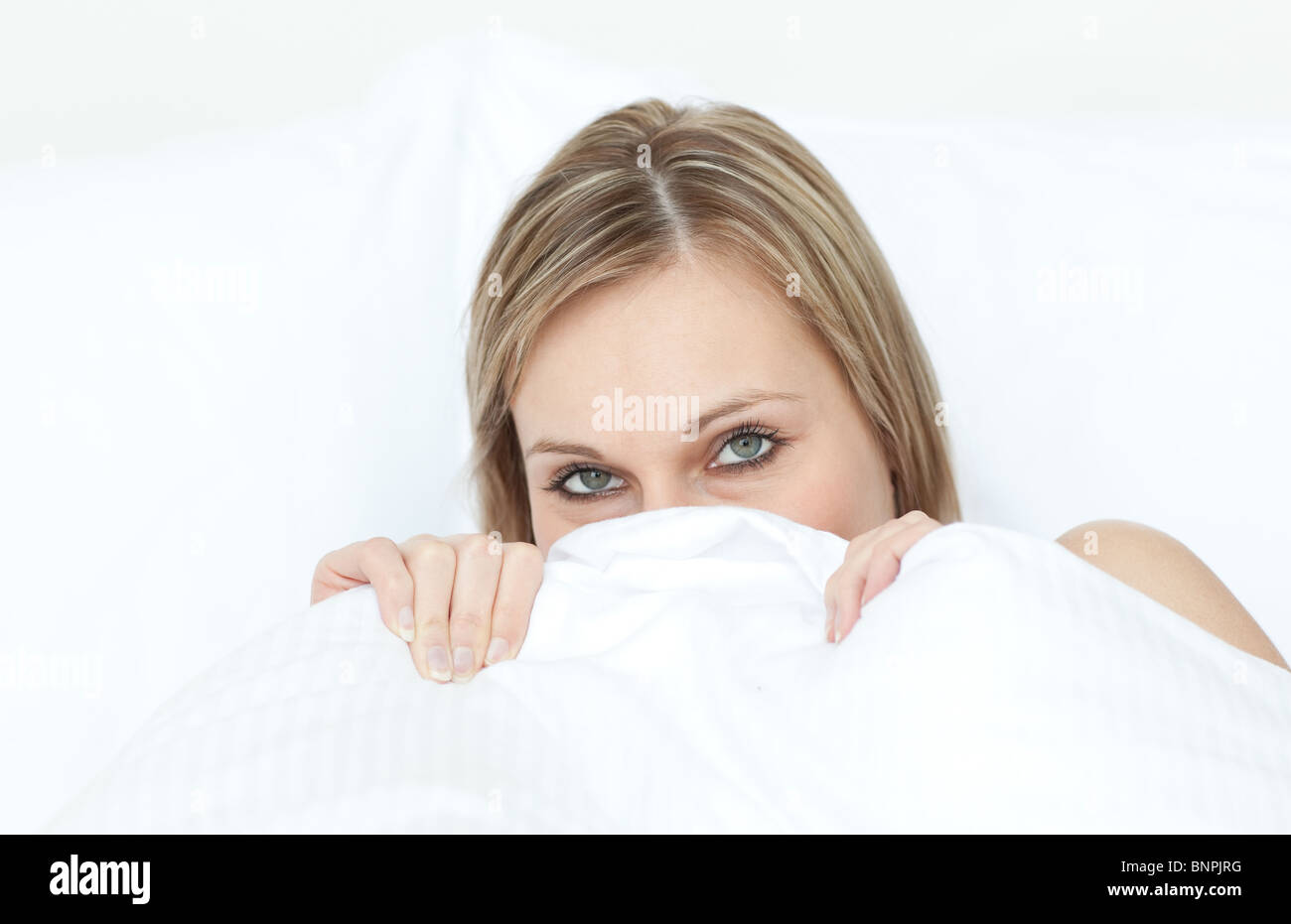 Close-up of a woman hiding in her bed Stock Photo - Alamy