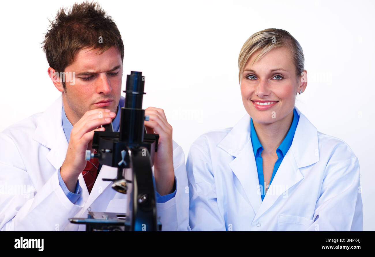 Science students looking through a microscope Stock Photo - Alamy