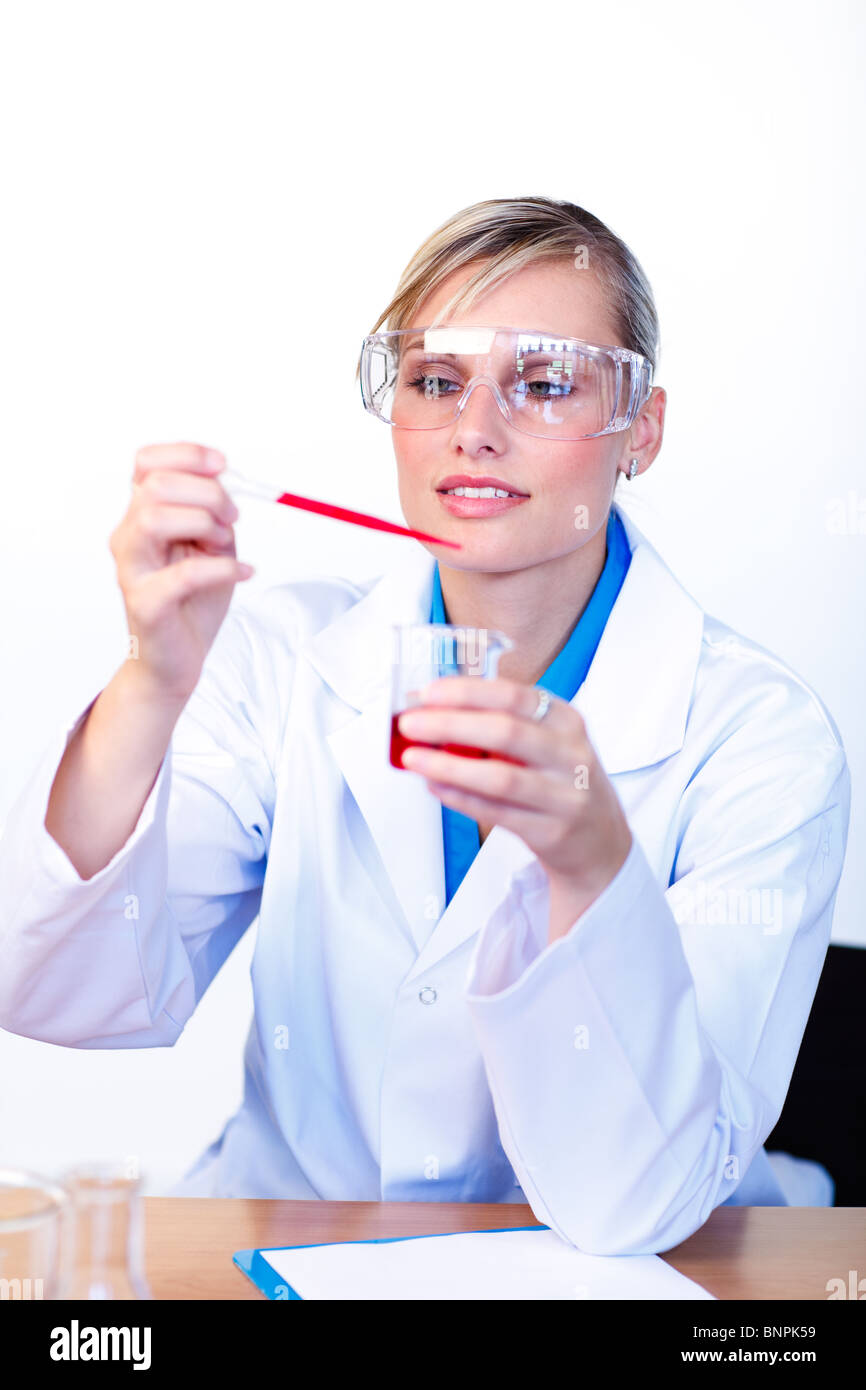 Female scientist examining a test-tube Stock Photo - Alamy