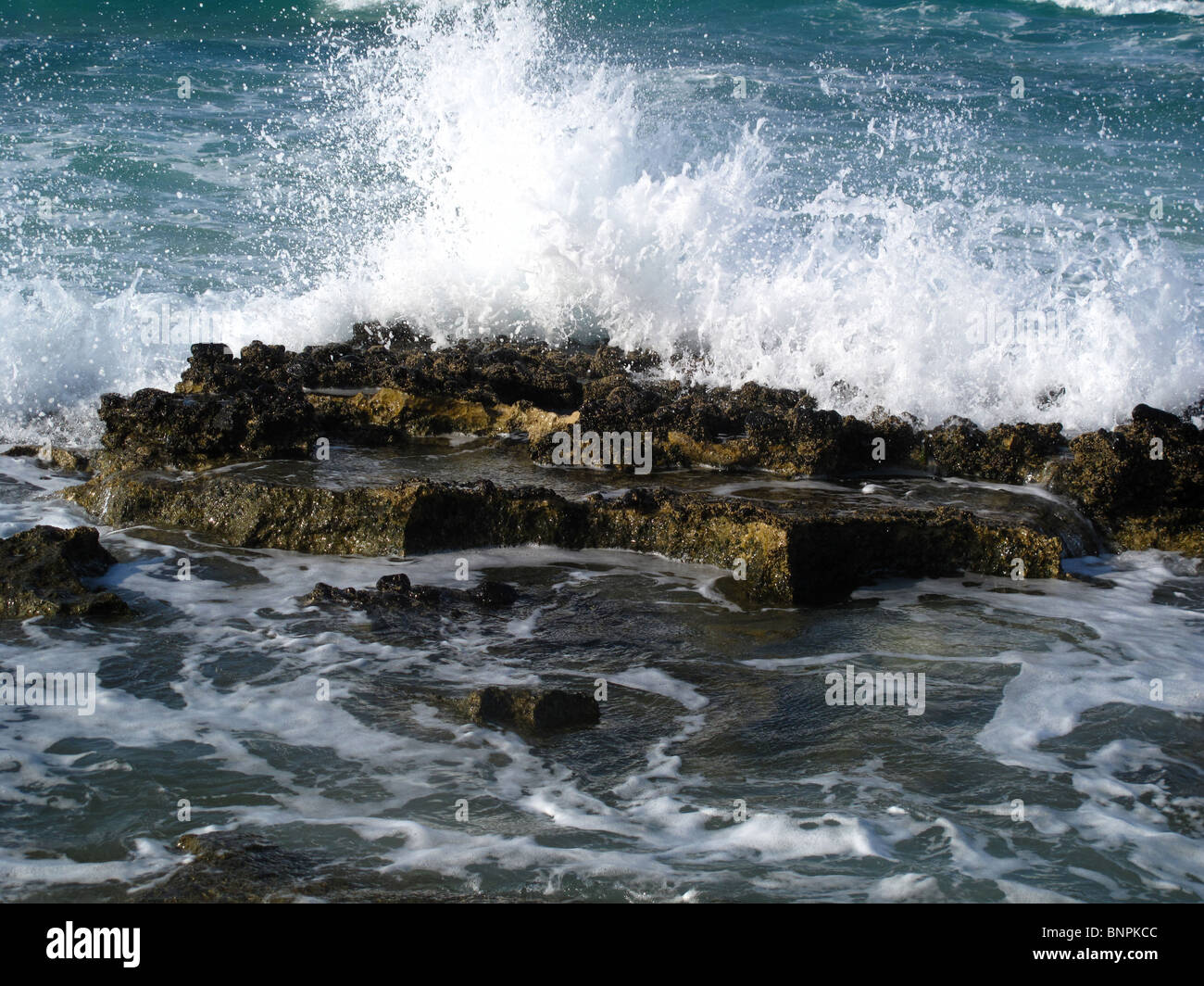 Waves crashing on rocks Stock Photo - Alamy