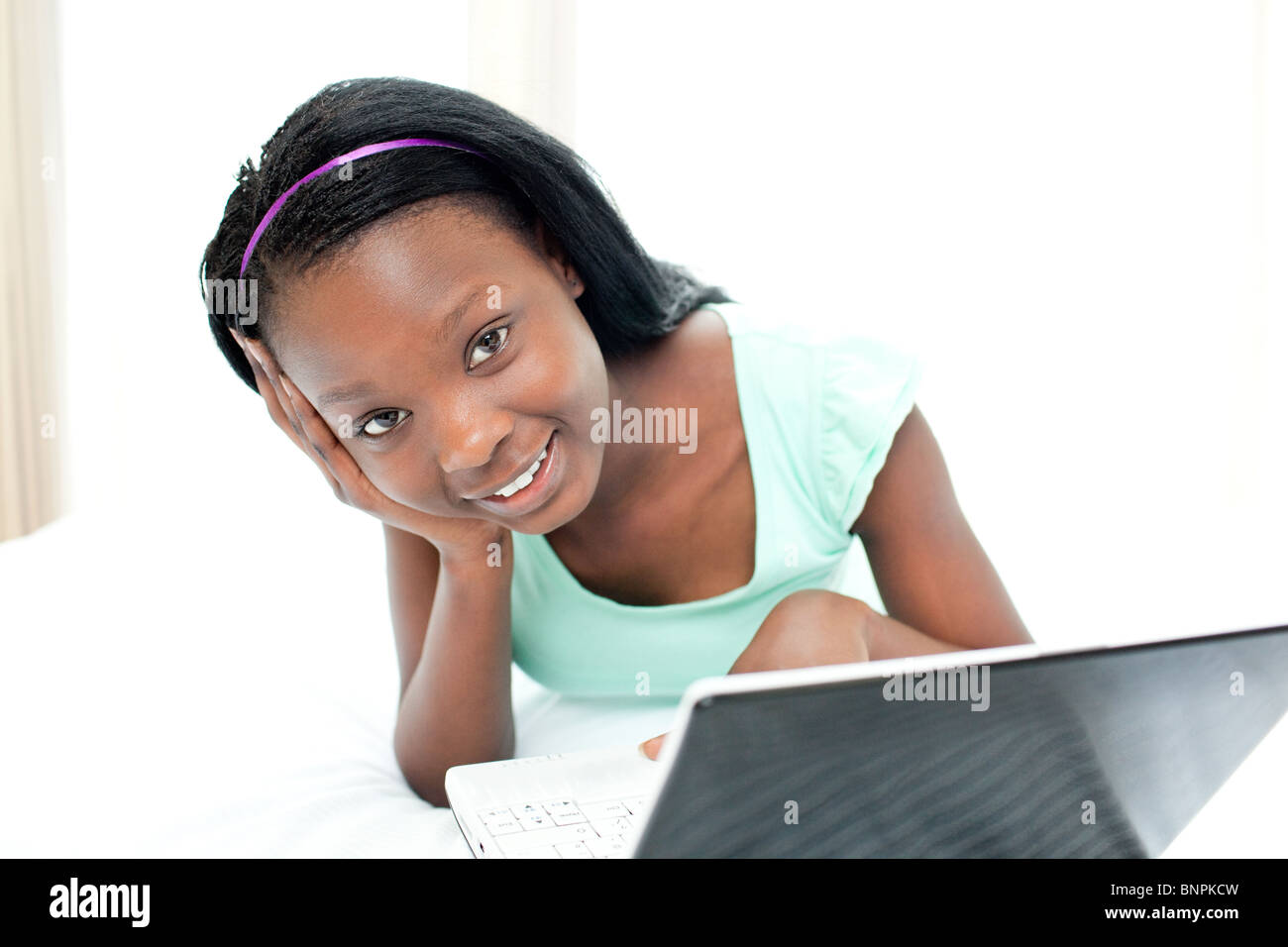 Jolly teen girl surfing the internet Stock Photo - Alamy