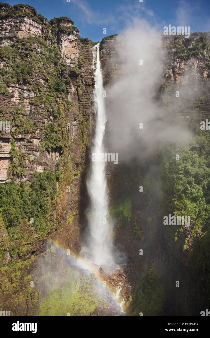 Aerial view of waterfall cascading over the side of sandstone cliffs of ...