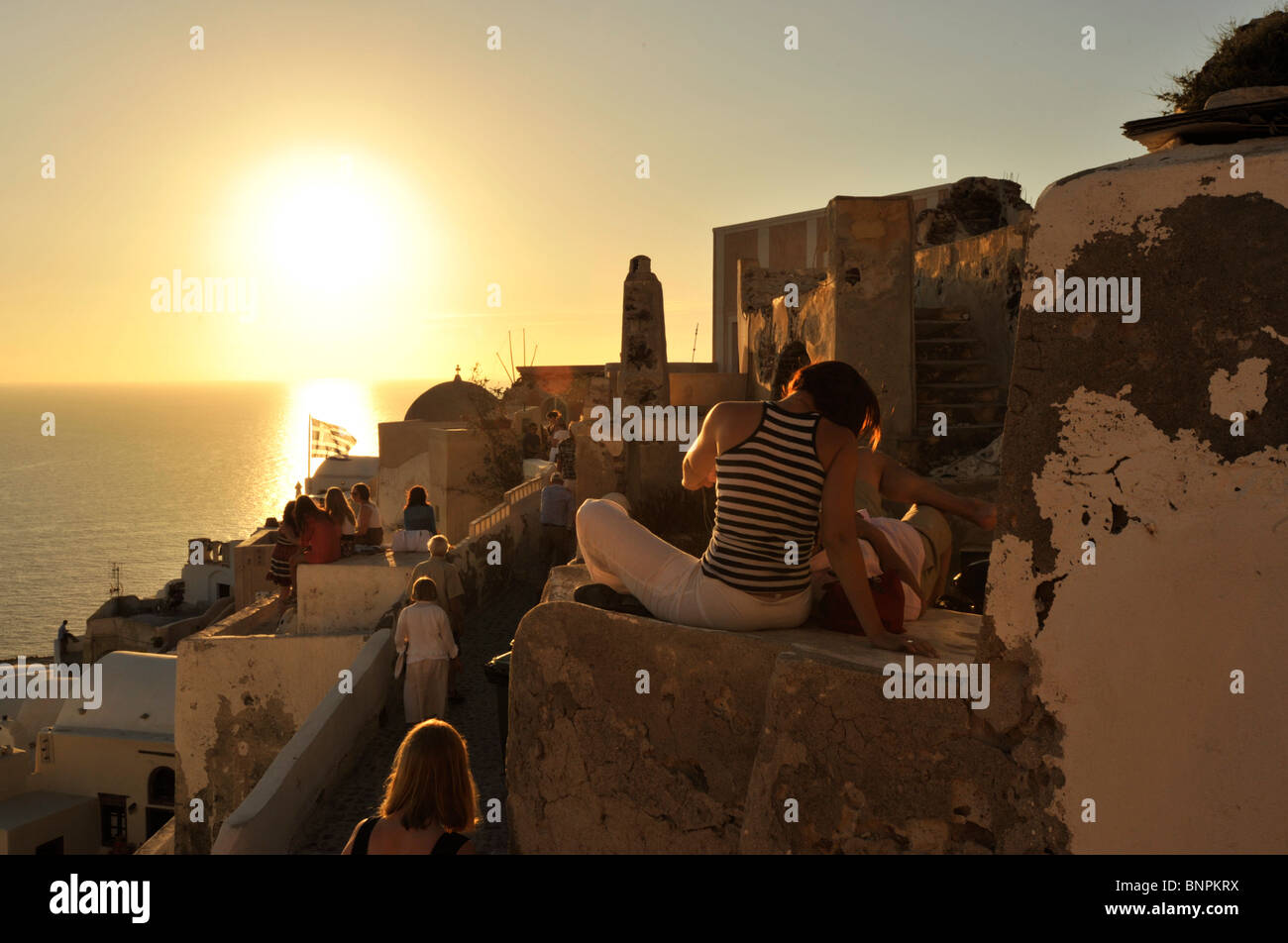 Crowds of young people gathered to see the sunset at Oia, Santorini in ...