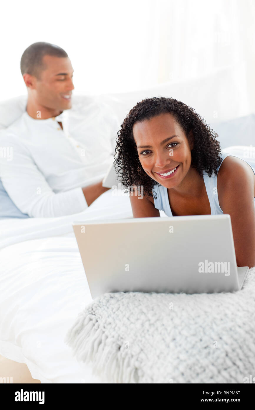 Smiling couple relaxing on their bed Stock Photo - Alamy