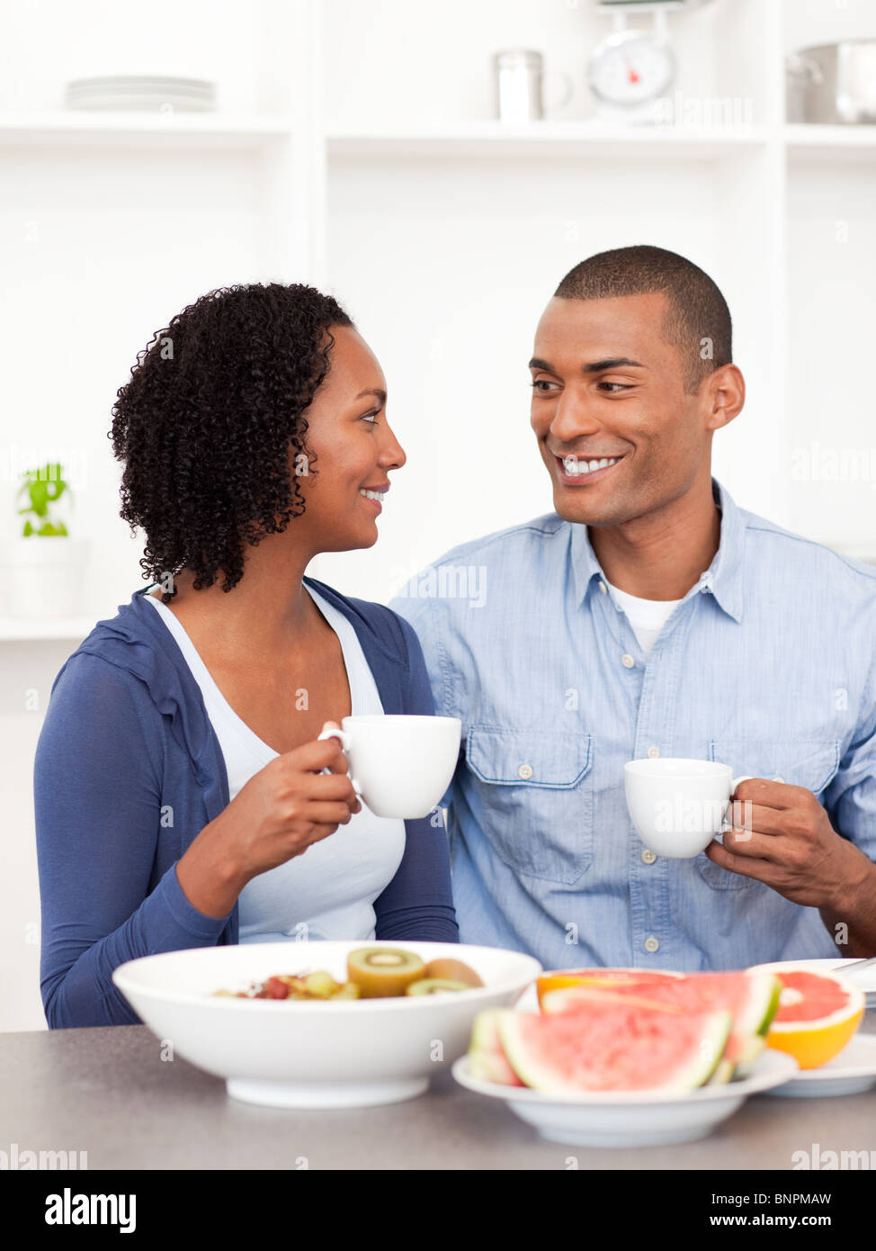 Smiling lovers having healthy breakfast Stock Photo - Alamy