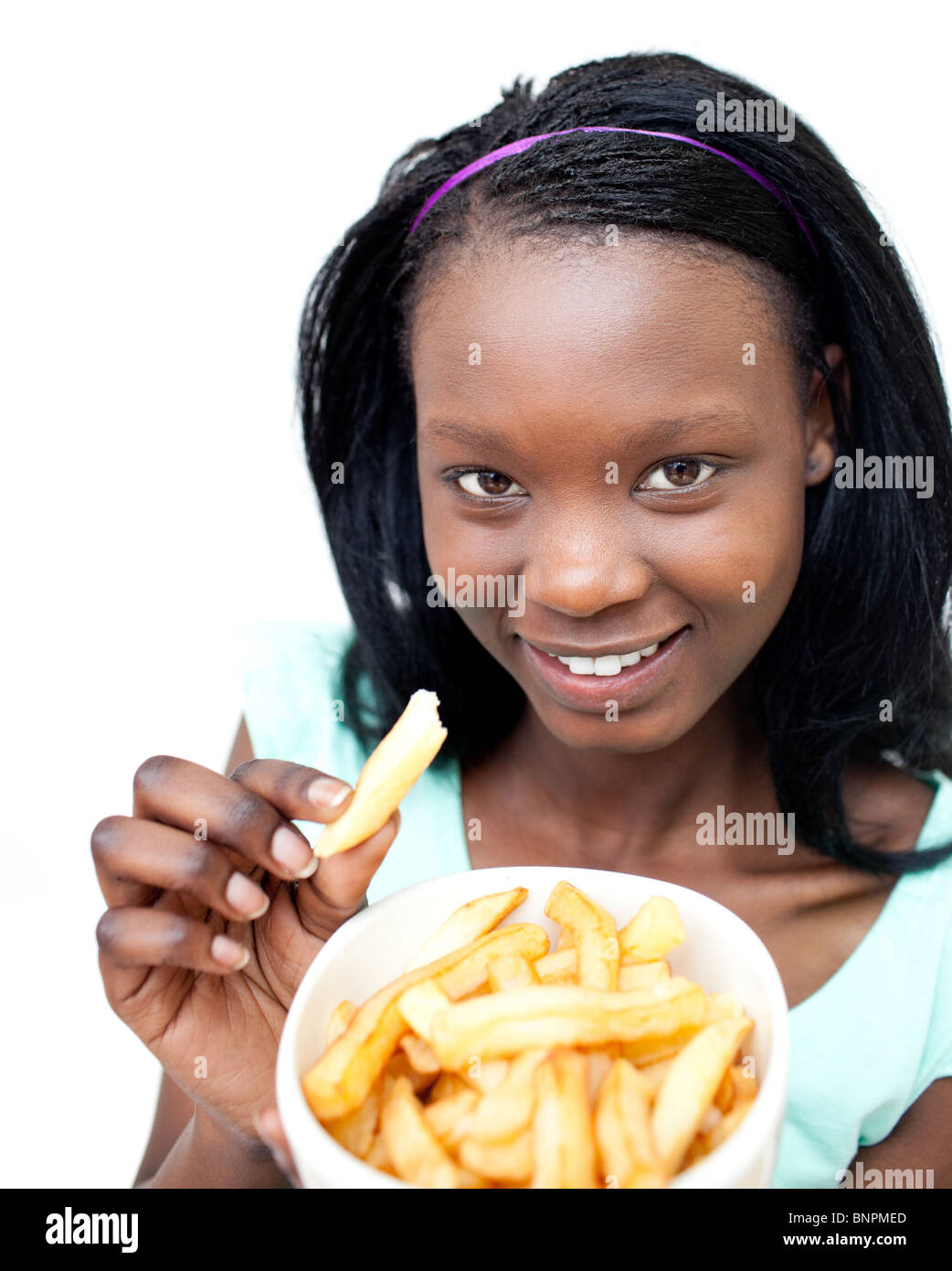 Charming young woman eating fries Stock Photo - Alamy