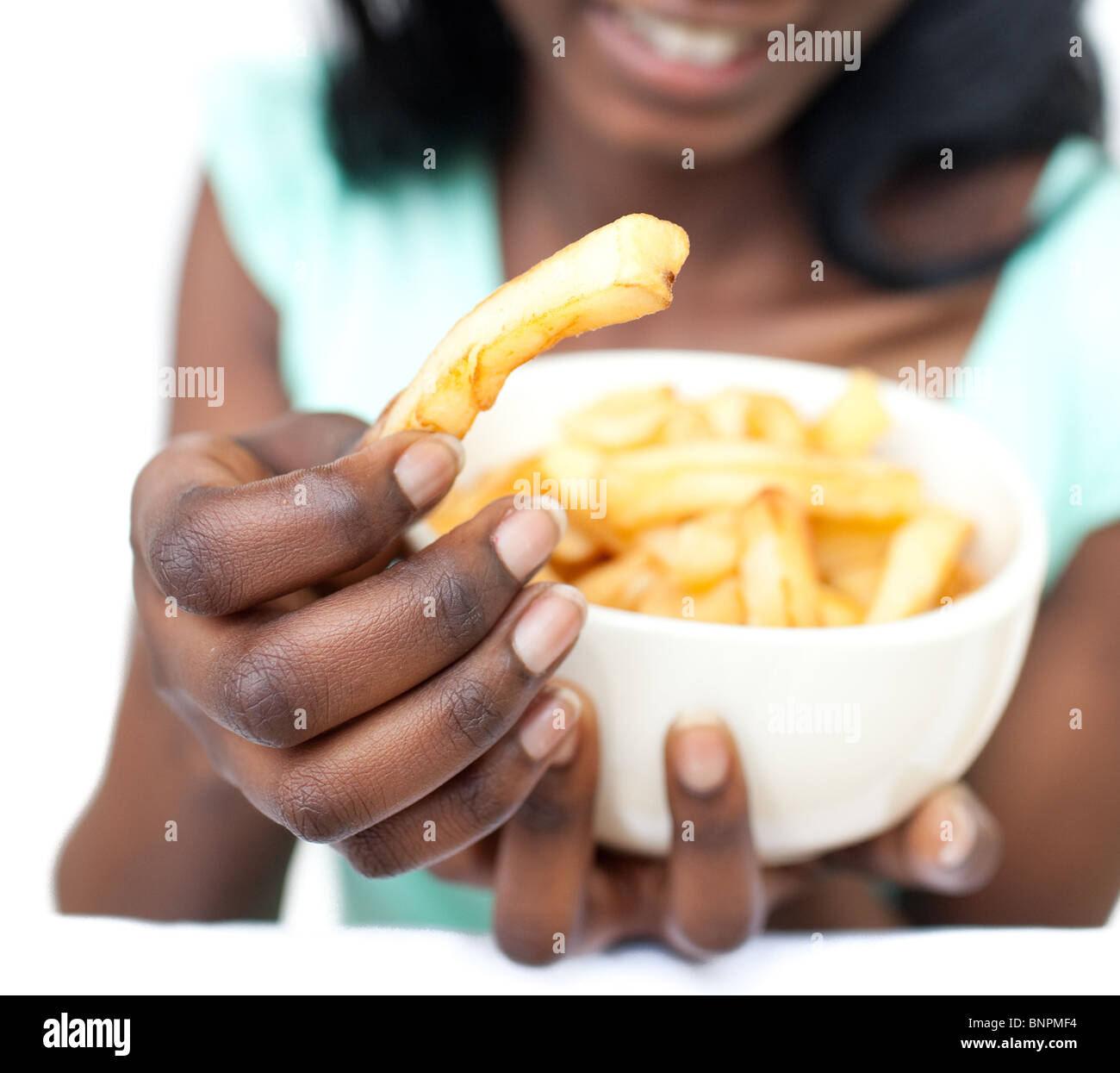 Young woman eating fries Stock Photo - Alamy