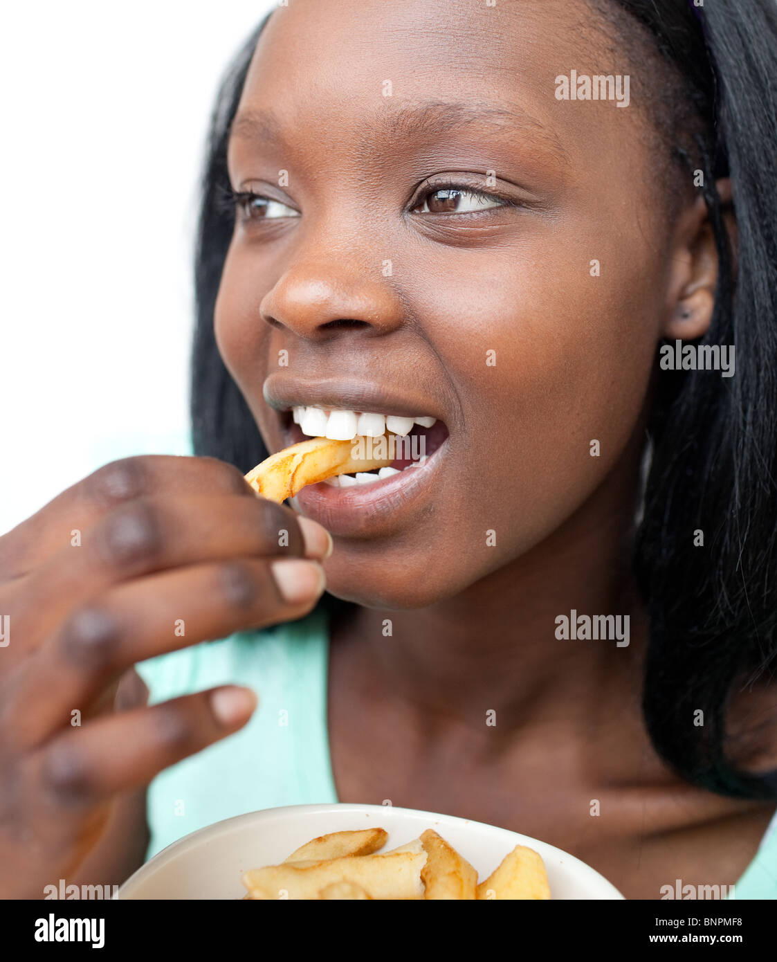 Jolly young woman eating fries Stock Photo - Alamy
