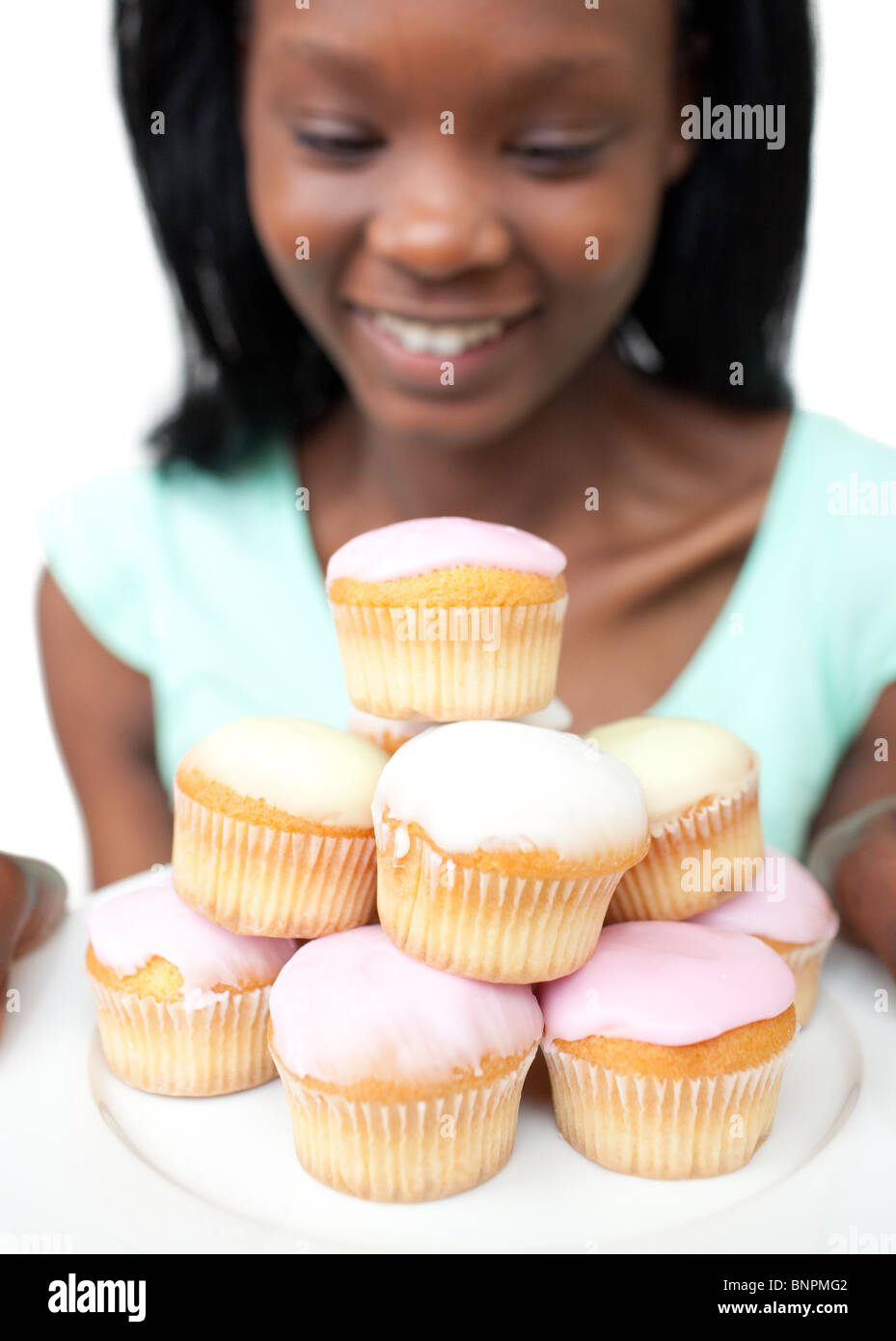 Smiling young woman looking at cakes Stock Photo - Alamy