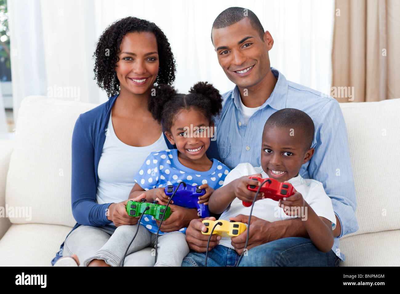 Smiling family playing video games Stock Photo - Alamy