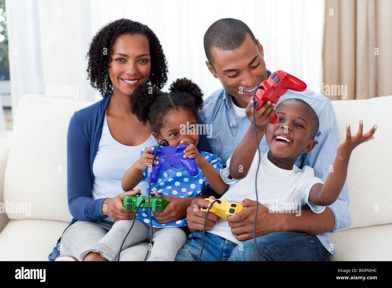 Happy family playing video games Stock Photo - Alamy