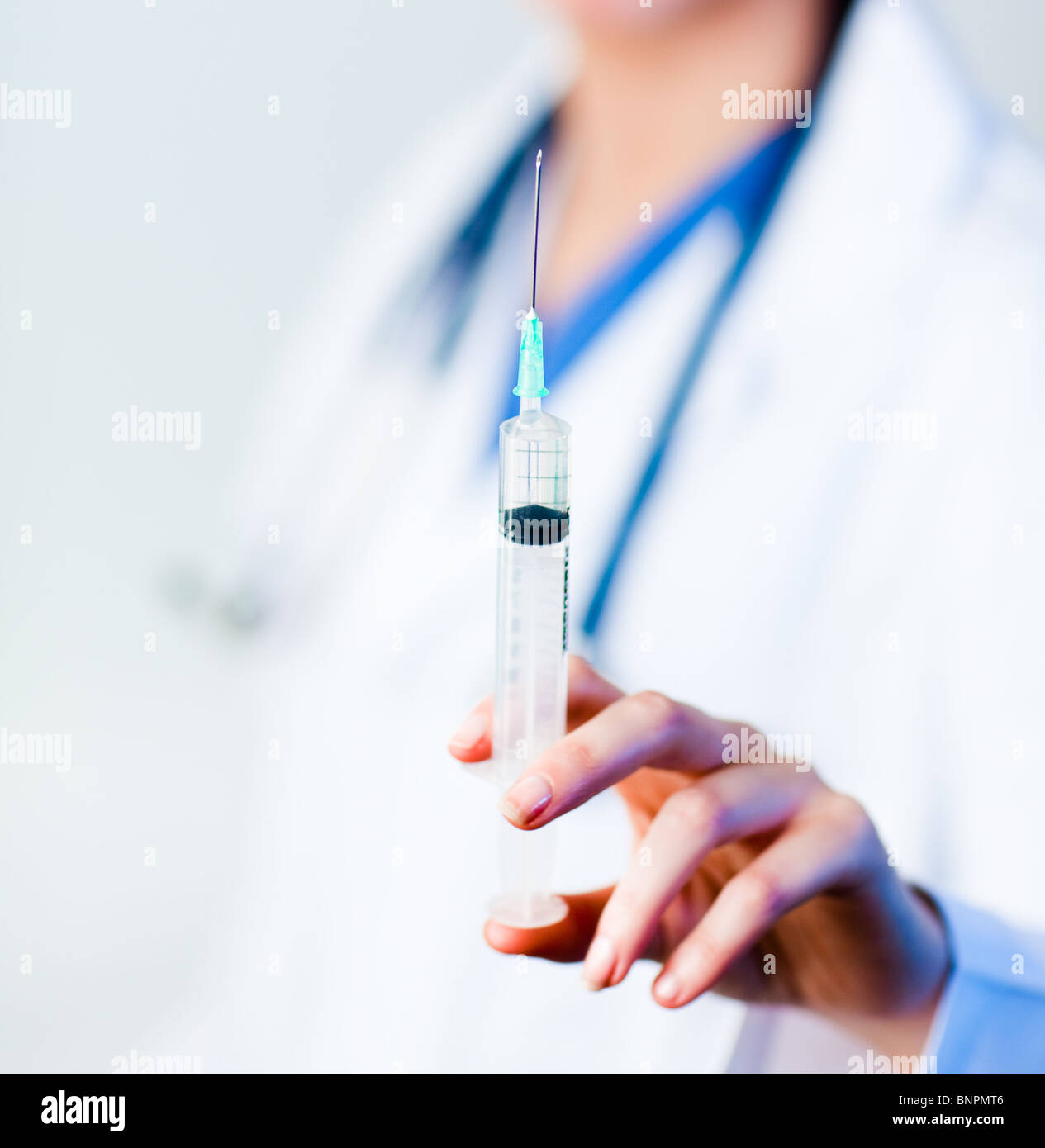 Doctor holding a needle Stock Photo - Alamy