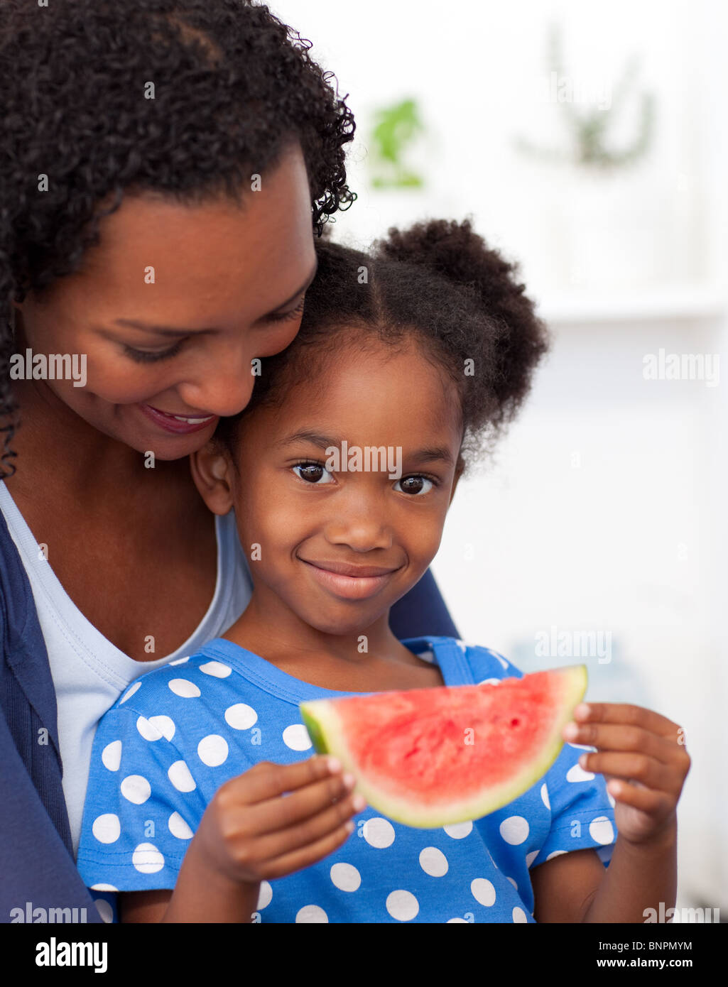 Portrait of a smiling girl eating fruit Stock Photo - Alamy