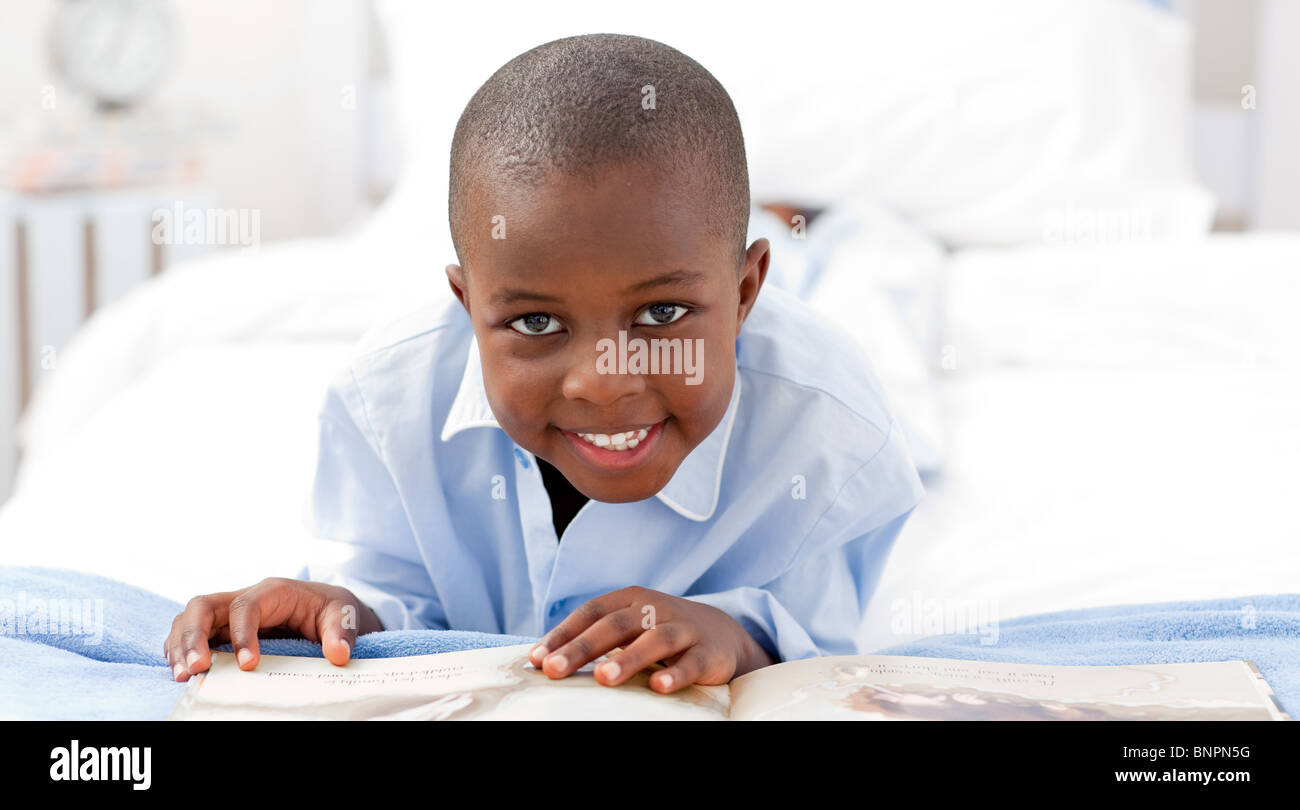 Small boy reading a book Stock Photo - Alamy