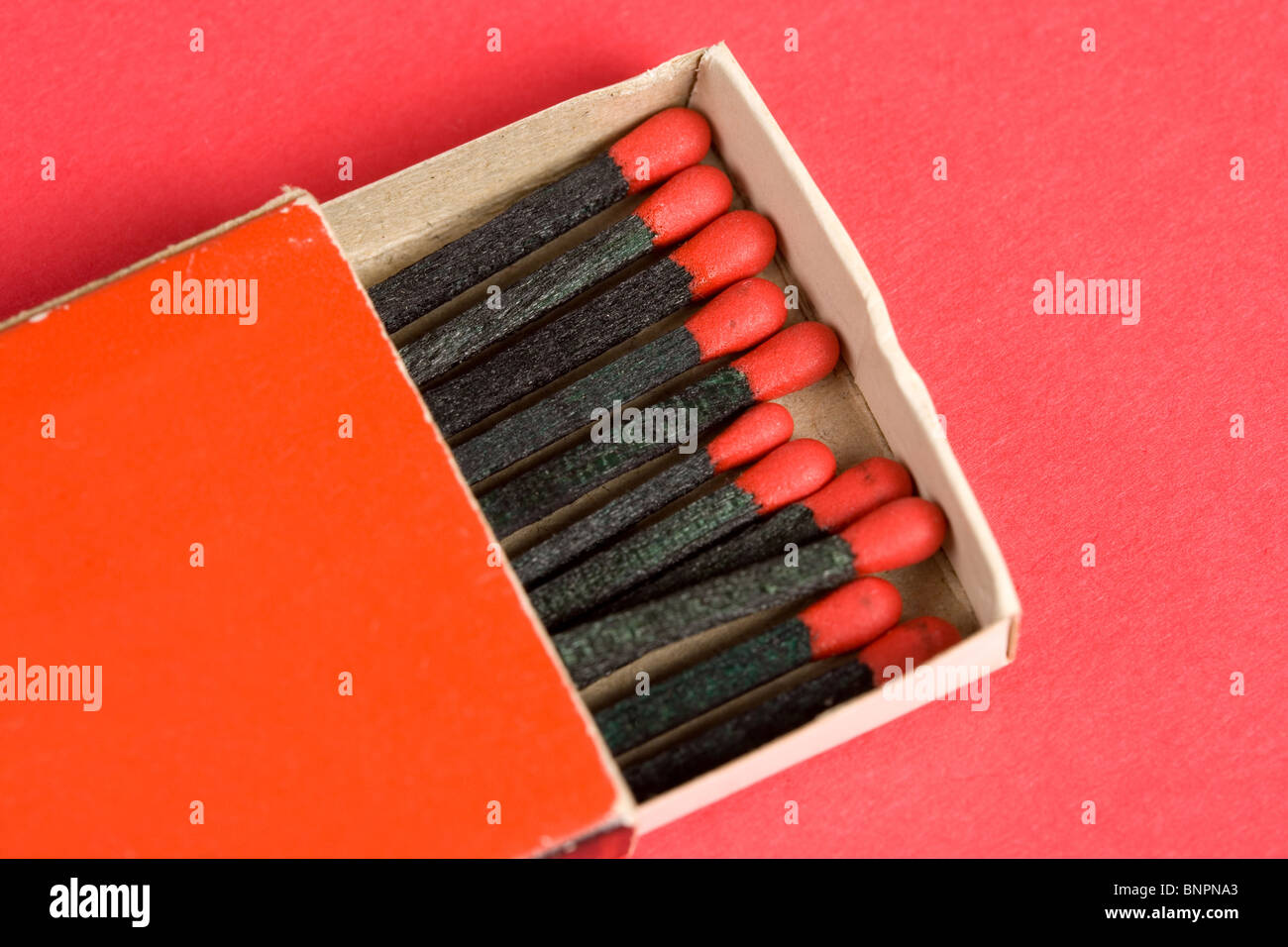 Black Match with red background Stock Photo - Alamy