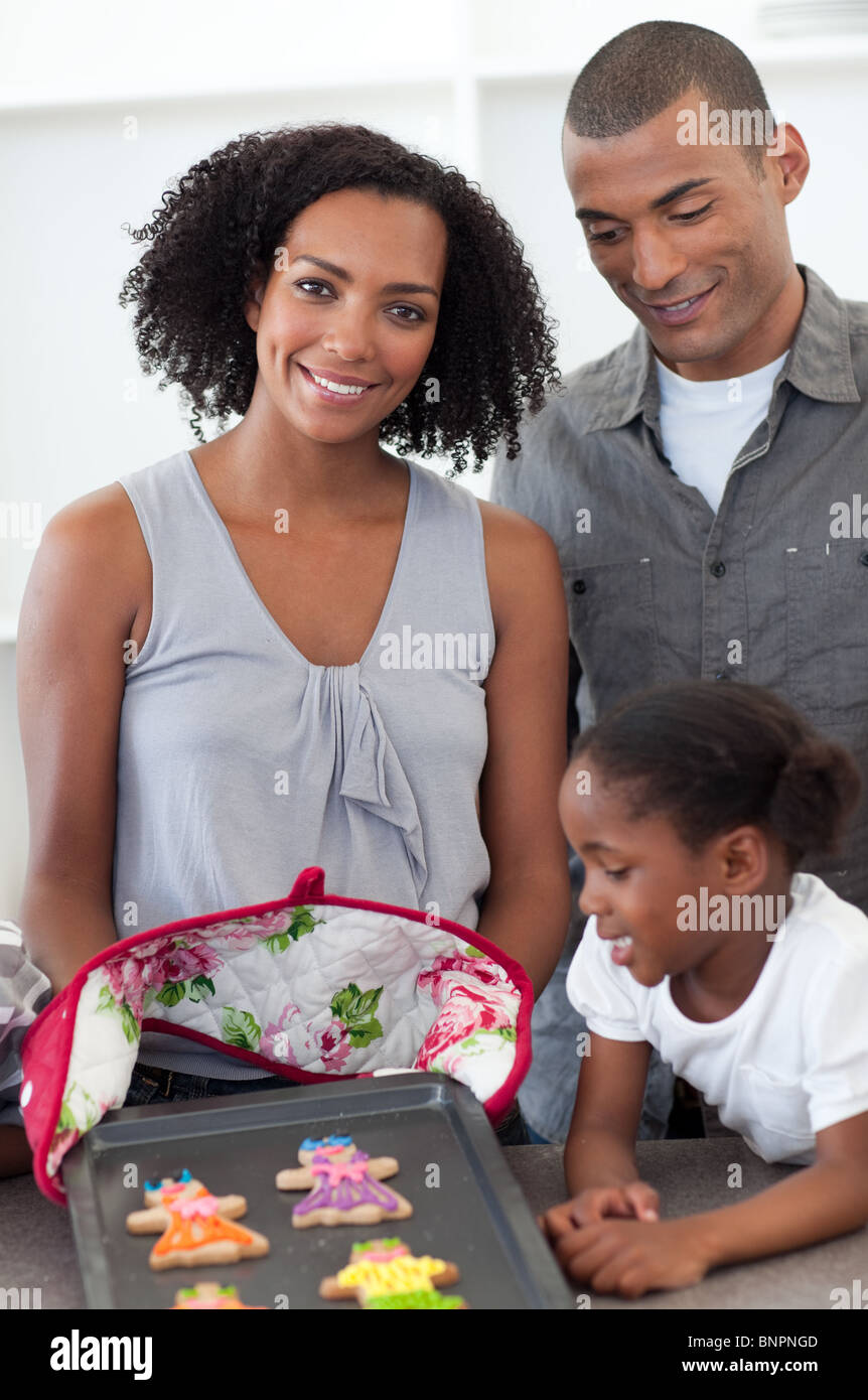 Smiling family showing handmade cookies Stock Photo - Alamy
