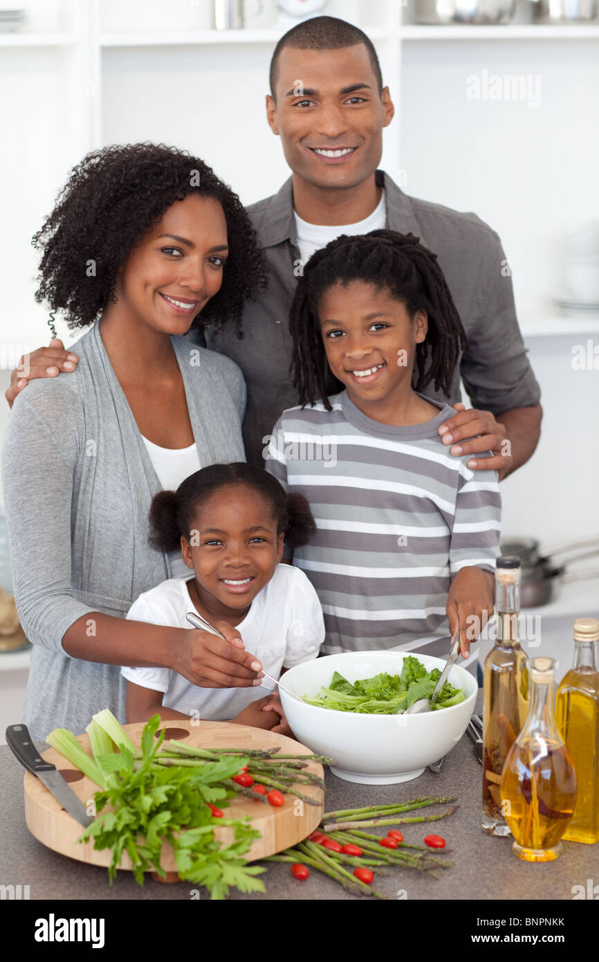 Family preparing salad together Stock Photo - Alamy