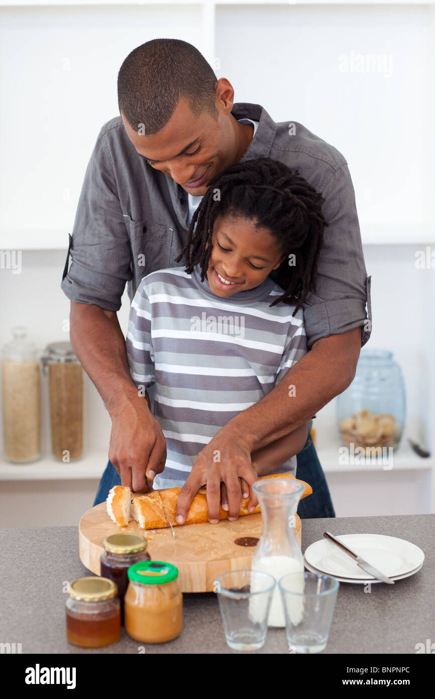 Happy father slicing bread with his son Stock Photo - Alamy