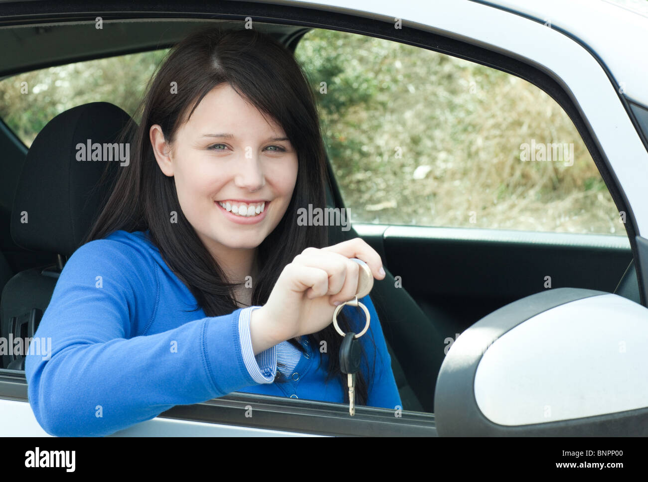 Happy teen girl sitting in her car holding keys Stock Photo - Alamy